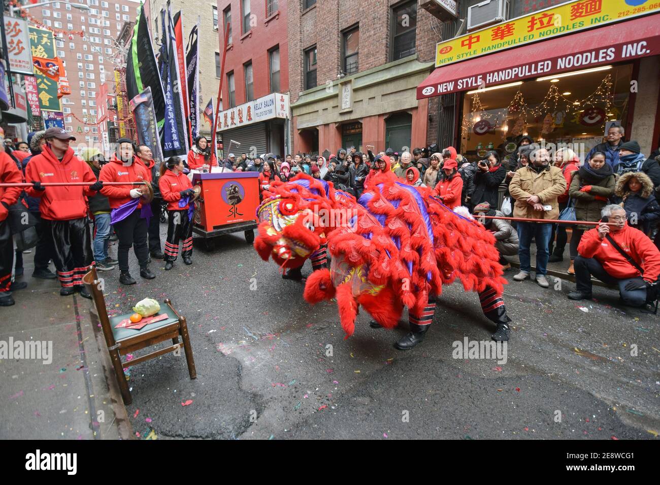 A dragon dance outside a restaurant on Pell Street in Chinatown in New ...