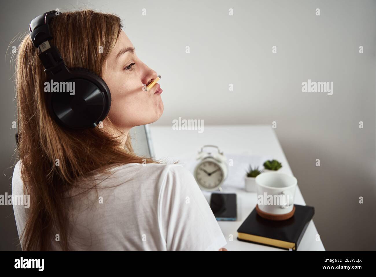 Freelancer woman sitting at workplace and procrastinating. Lazy and ...