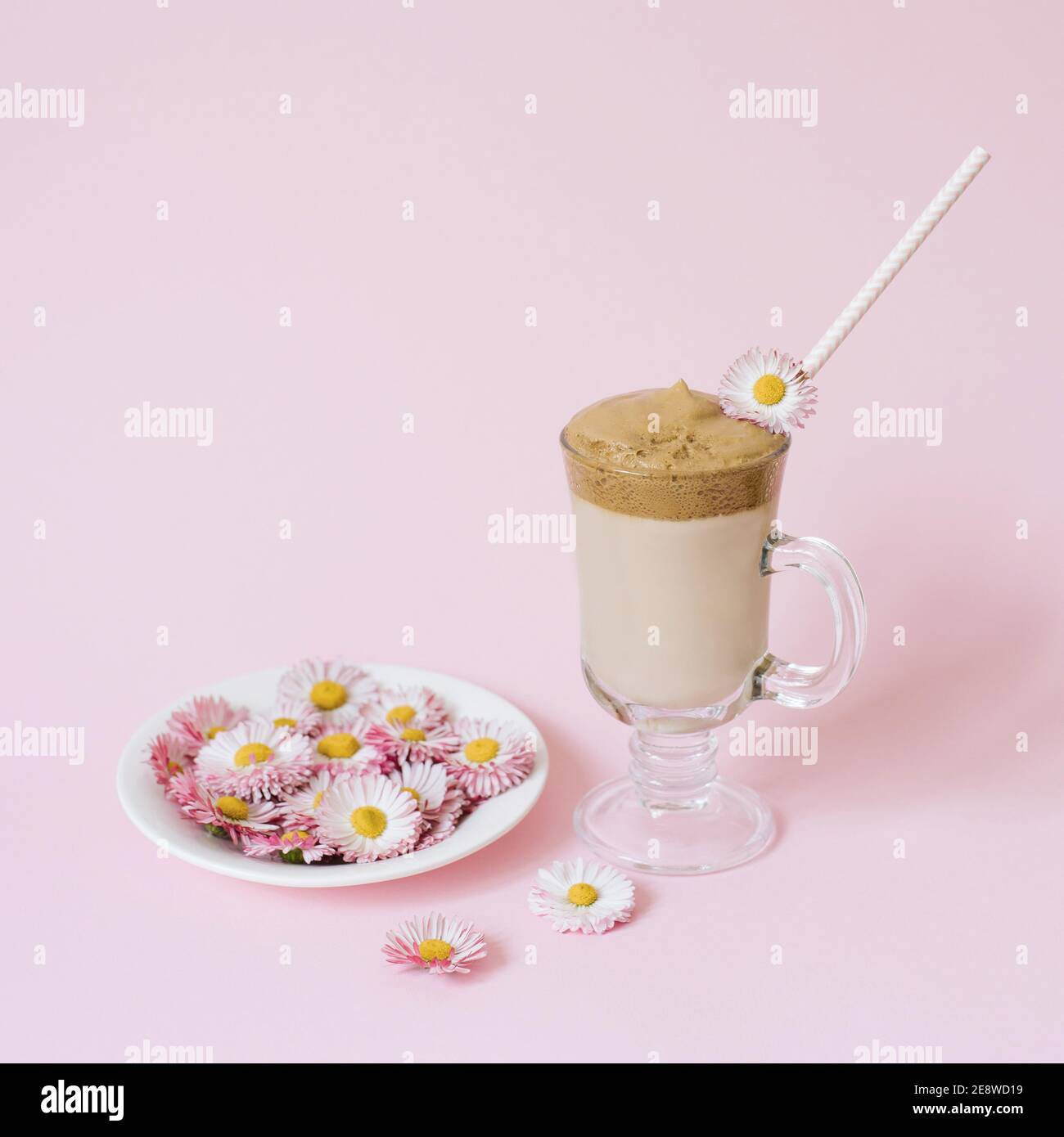 dalgona Coffee in a transparent Cup with a paper tube, a plate with ...