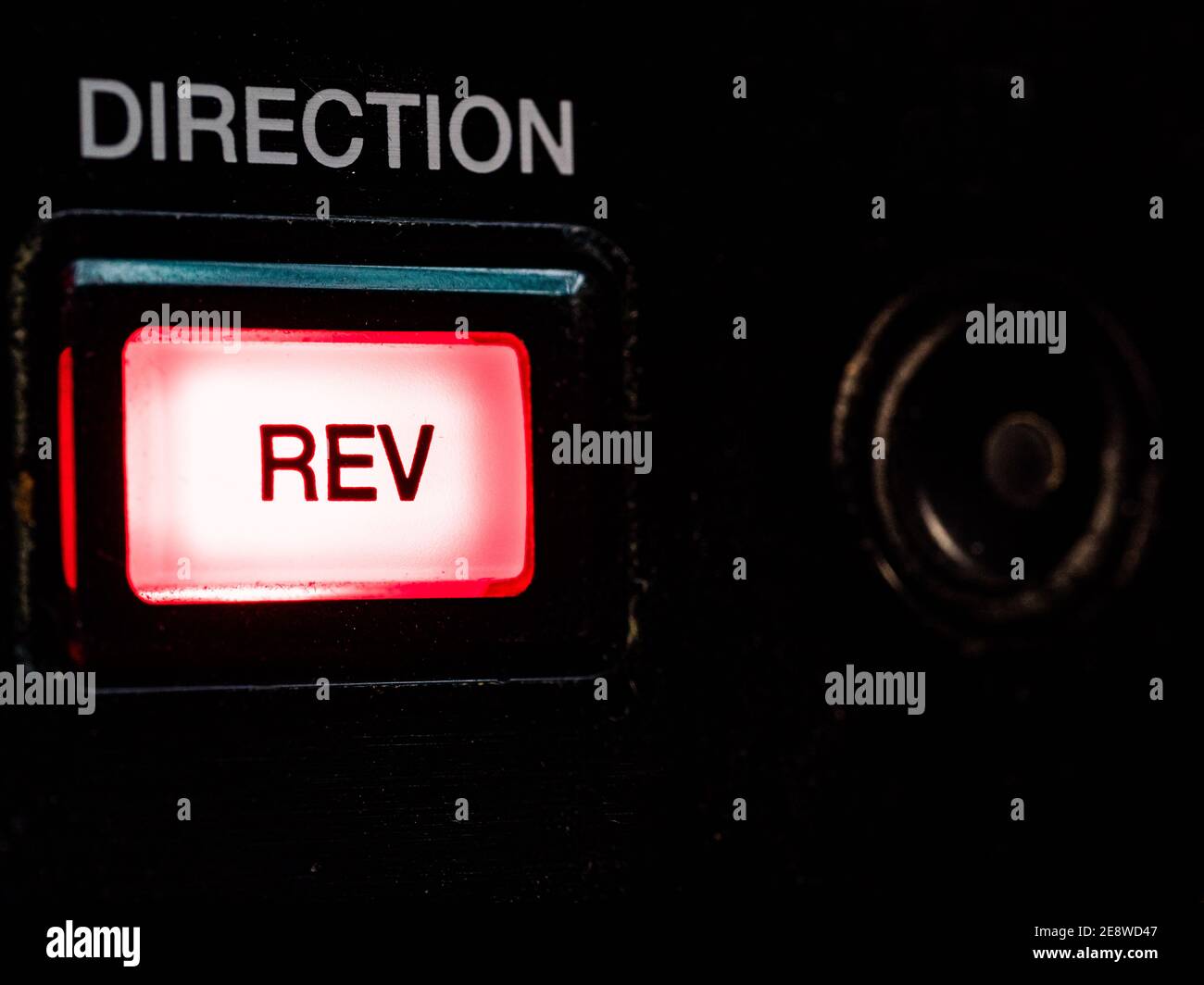 Illuminated 'Rev(erse)' button on a DJ mixing deck Stock Photo - Alamy