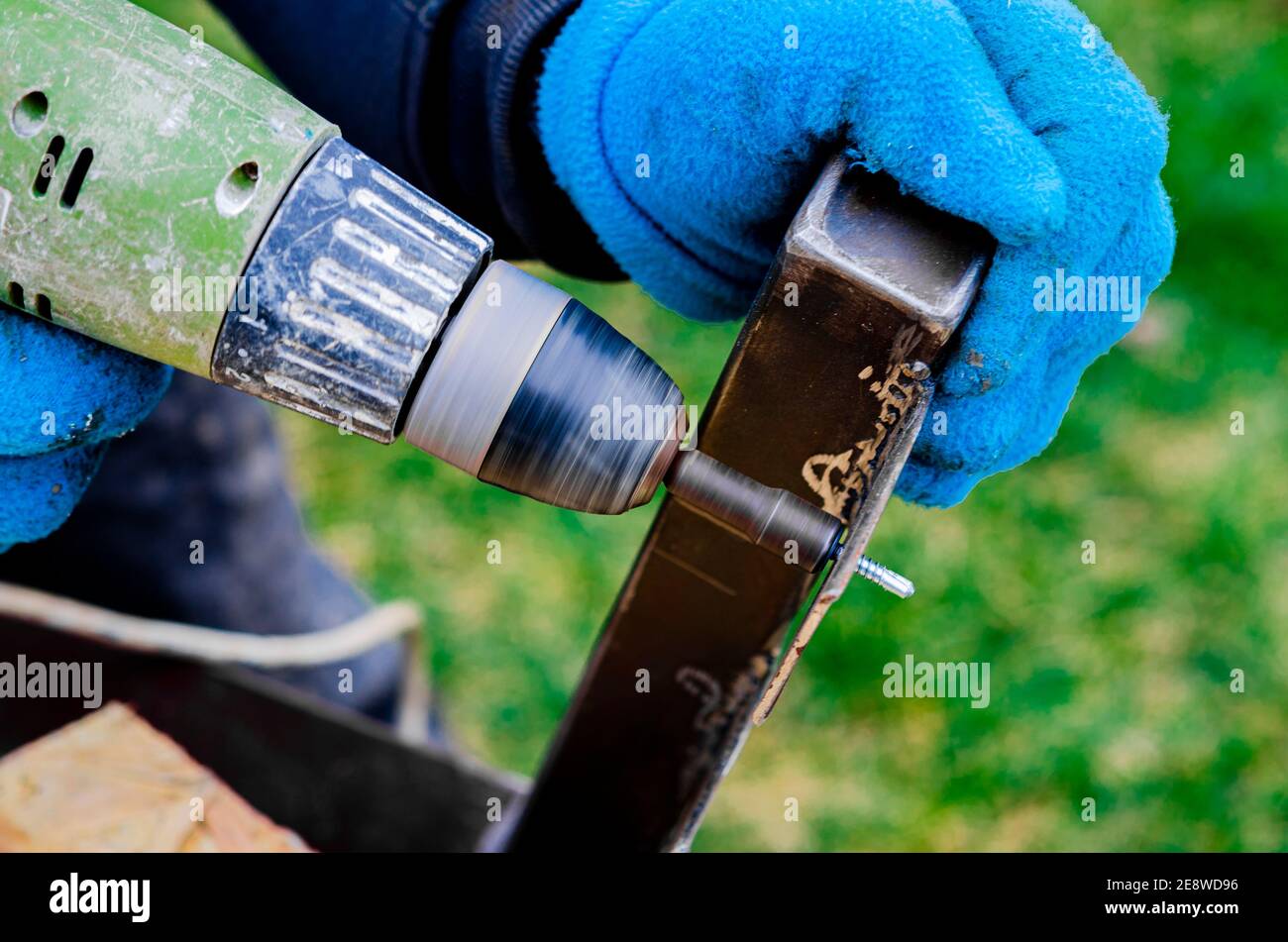 Dealing with a power tool. The man's hands are in gloves with a drill ...