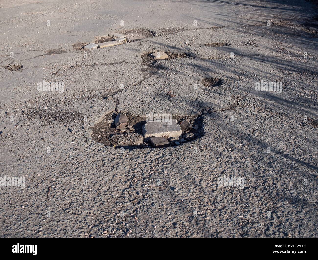 Pothole in the street in a city Stock Photo - Alamy
