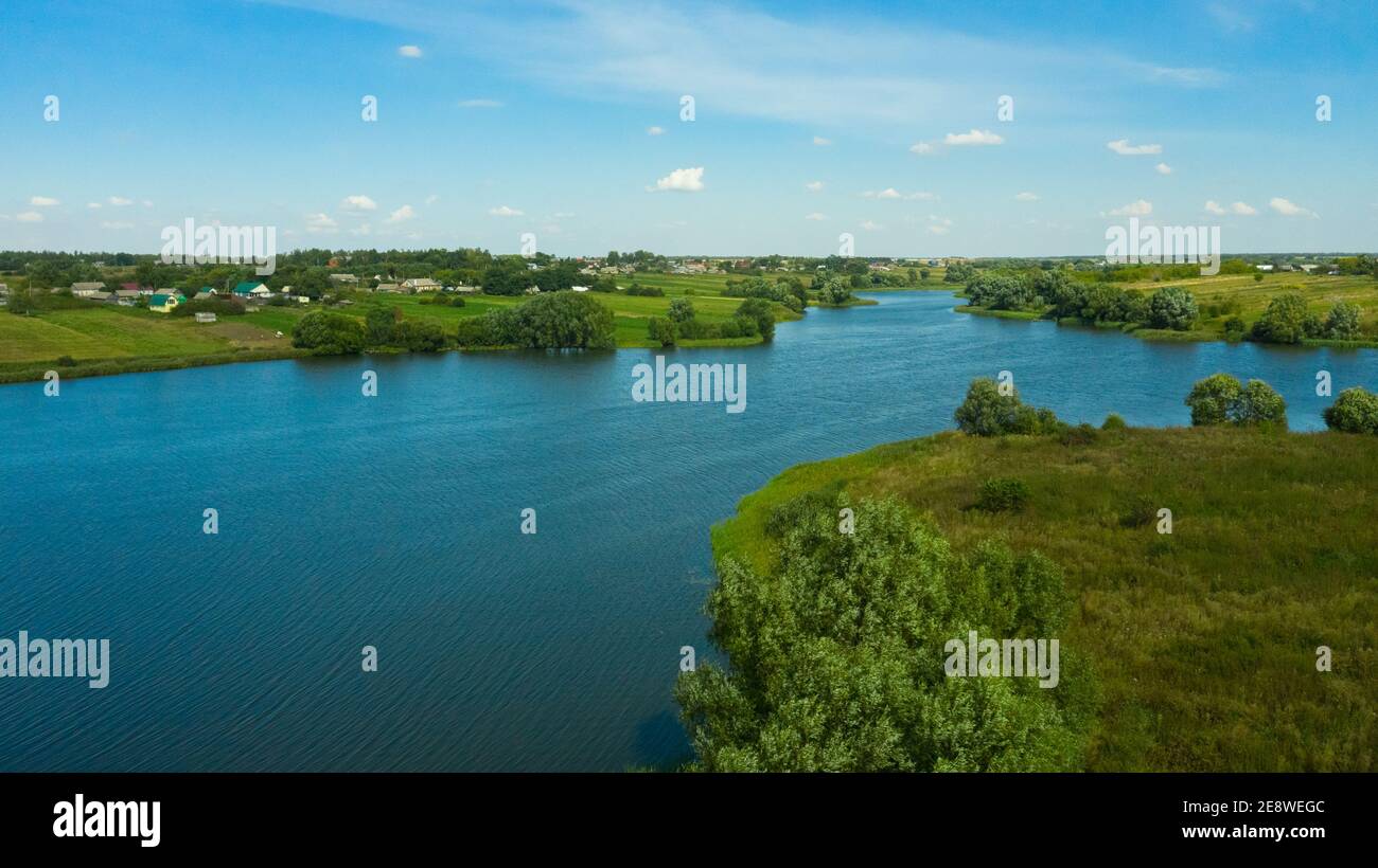 Scenic aerial view of river and green fields in Russian countryside ...