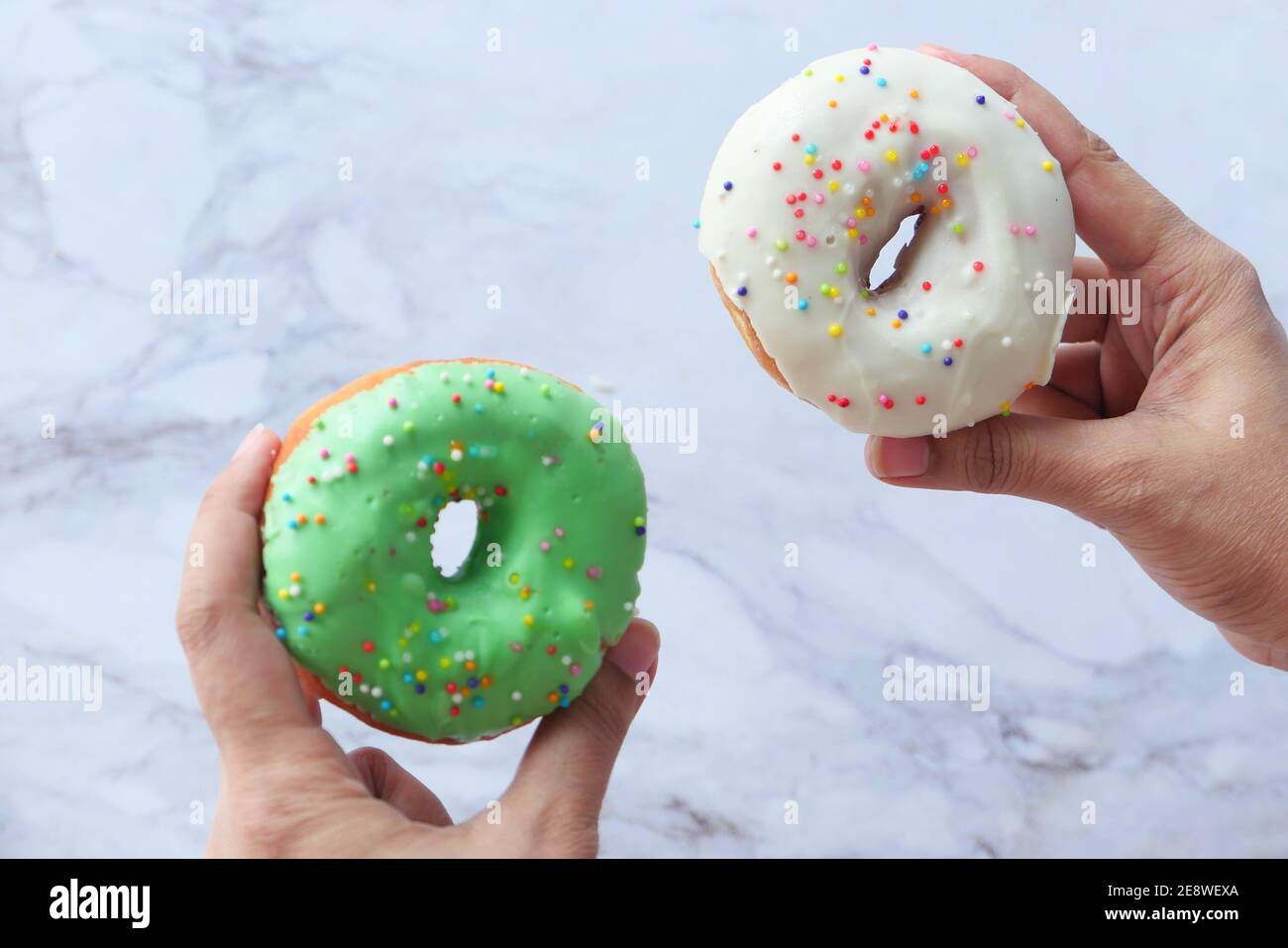 Holding up donuts hi-res stock photography and images - Alamy