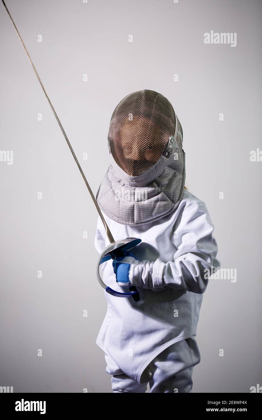 Children lunge on swords. A child in a class at a fencing school Stock ...