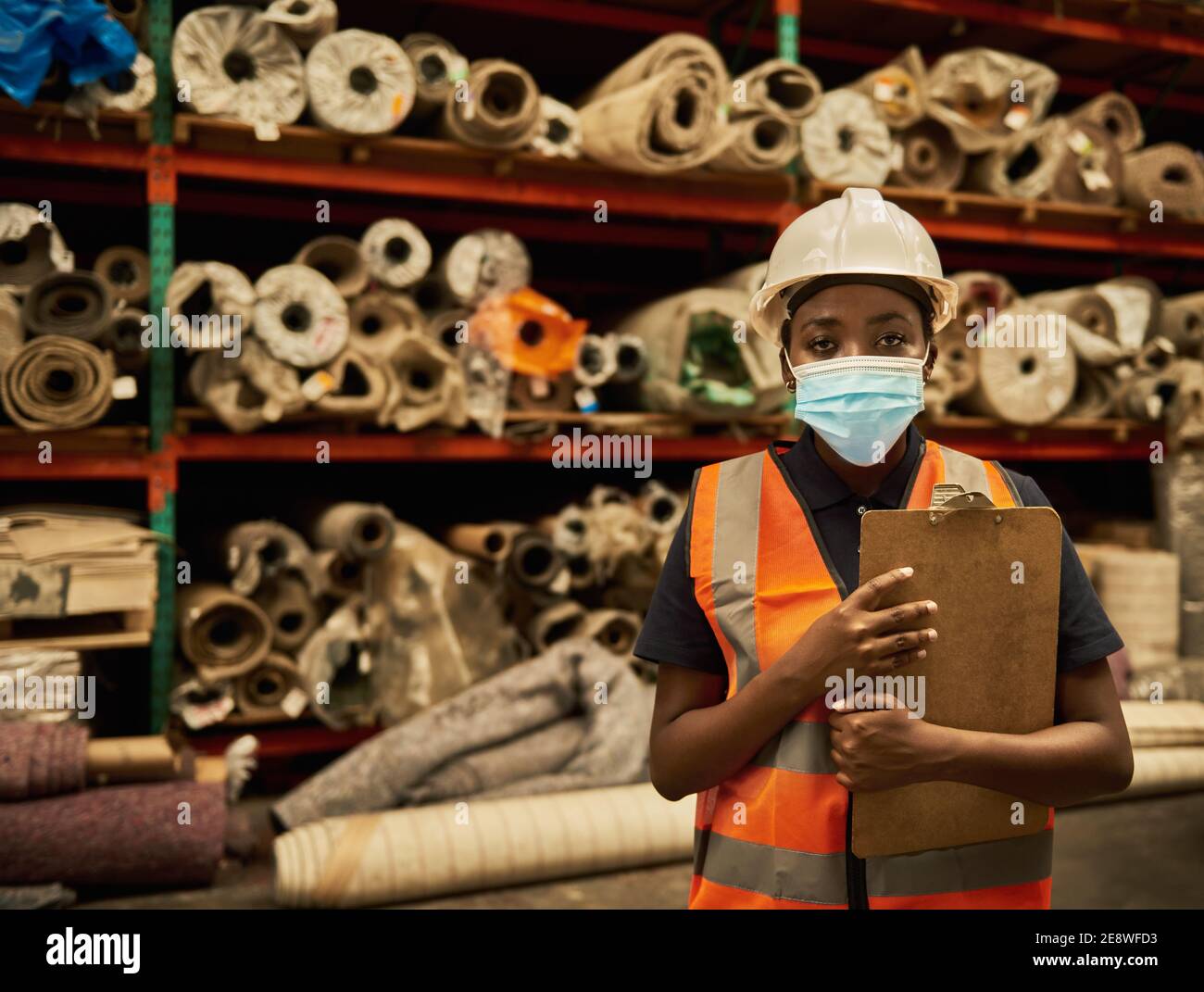 African worker wearing a face mask in a warehouse Stock Photo - Alamy
