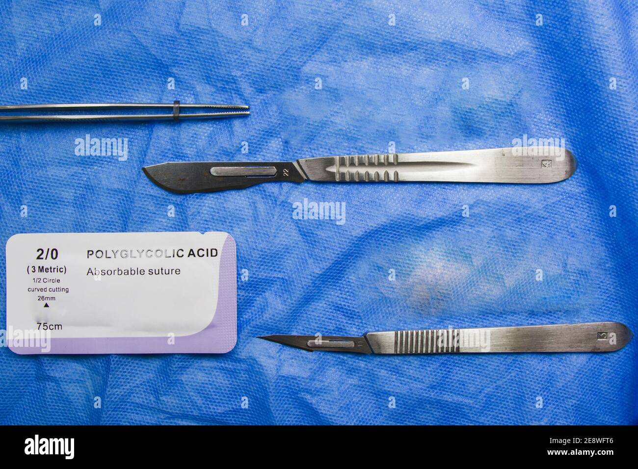 Top view of medical scalpels on a blue fabric surface Stock Photo - Alamy