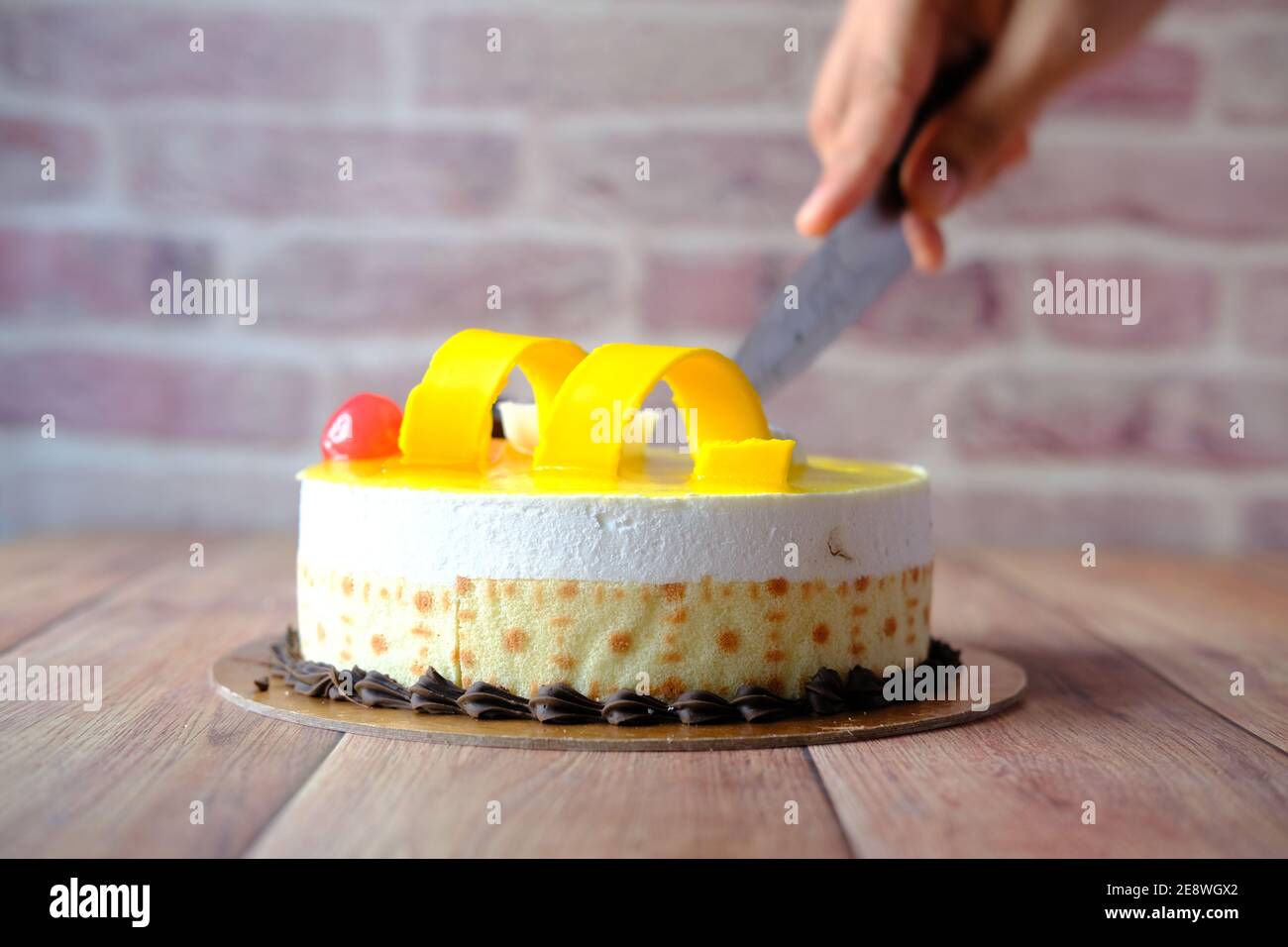 Hand cutting chocolate cake hi-res stock photography and images - Alamy