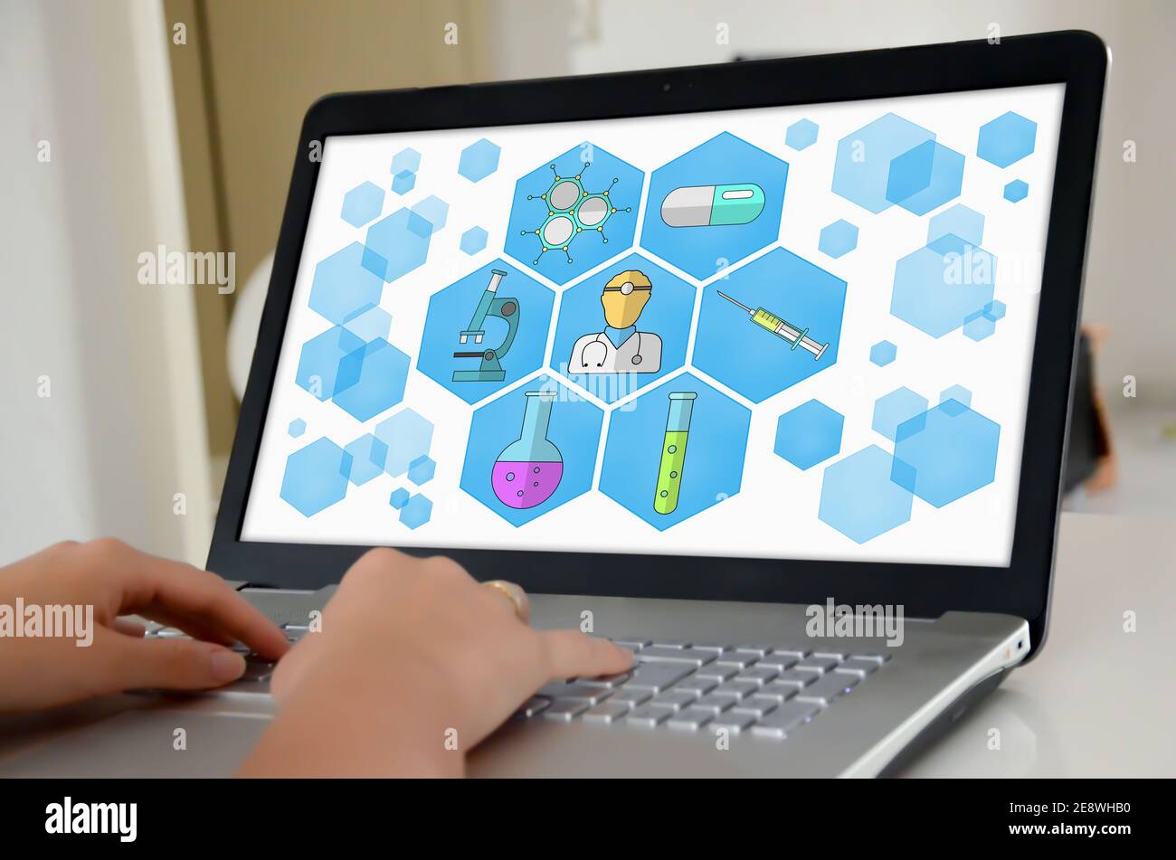 Hands on a laptop with screen showing medical research concept Stock ...