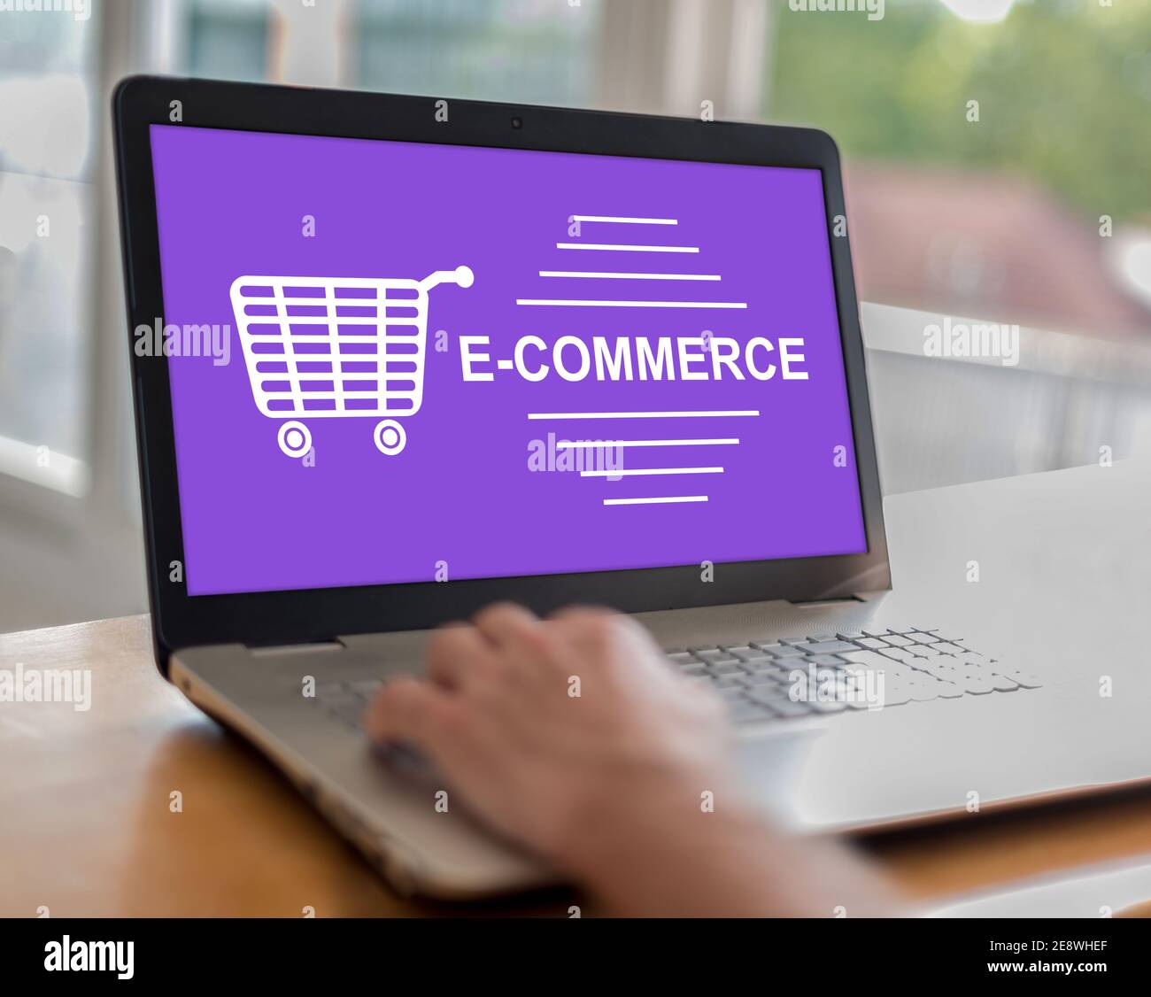 Man using a laptop with e-commerce concept on the screen Stock Photo - Alamy