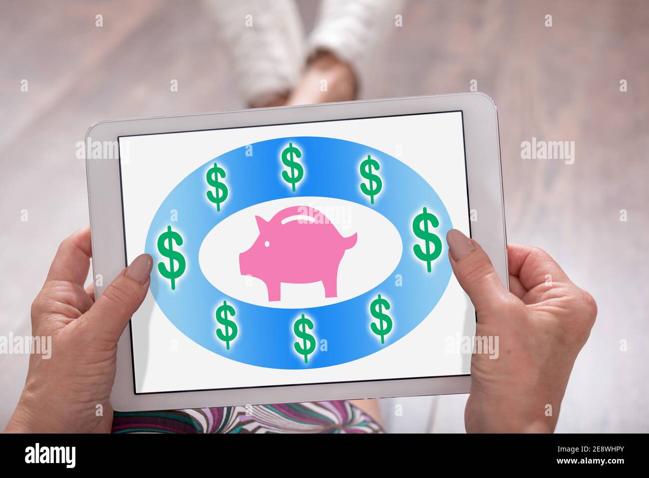 Saving money concept shown on a tablet held by a woman Stock Photo - Alamy