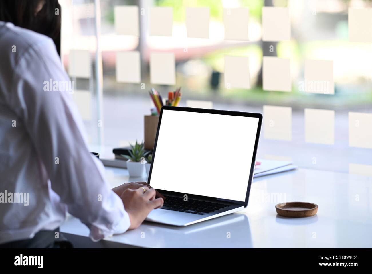 Rear view of young woman office worker working on computer laptop at ...