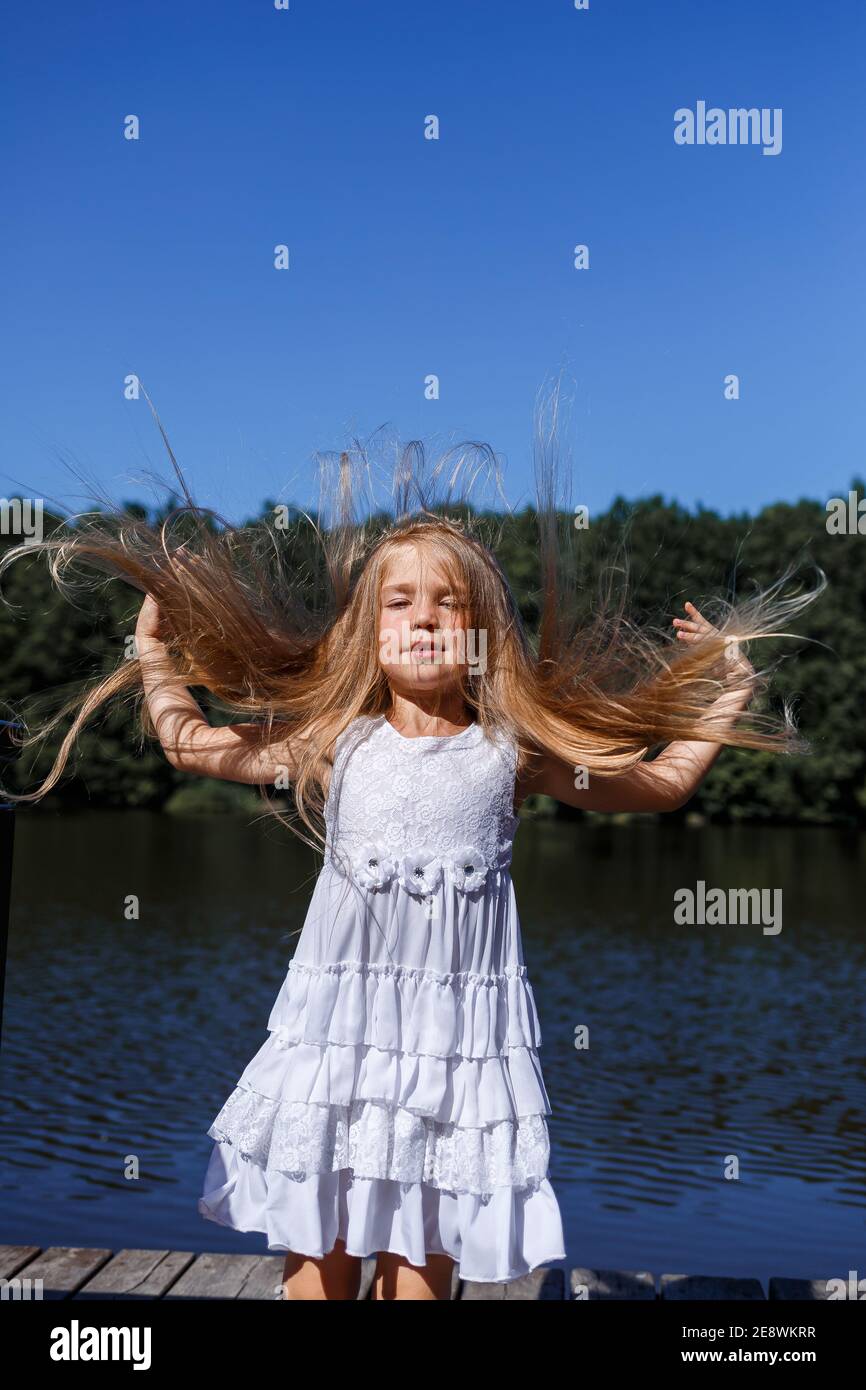 A Six Year Old Girl Is Wearing A White Dress Beautiful Long Hair Walk