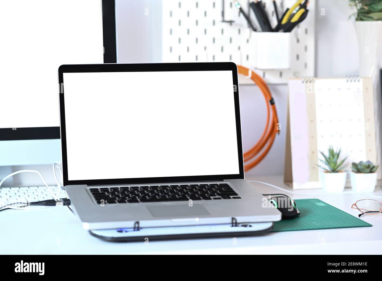 Laptop computer with white screen on graphic designer workspace Stock ...