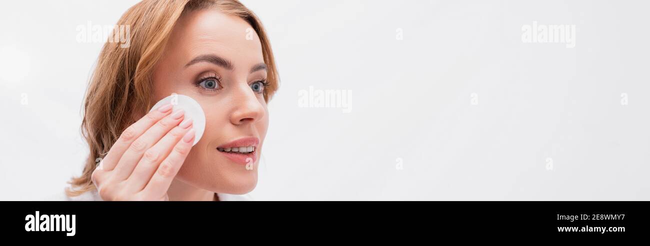 happy woman applying toner with cotton pad on face, banner Stock Photo ...