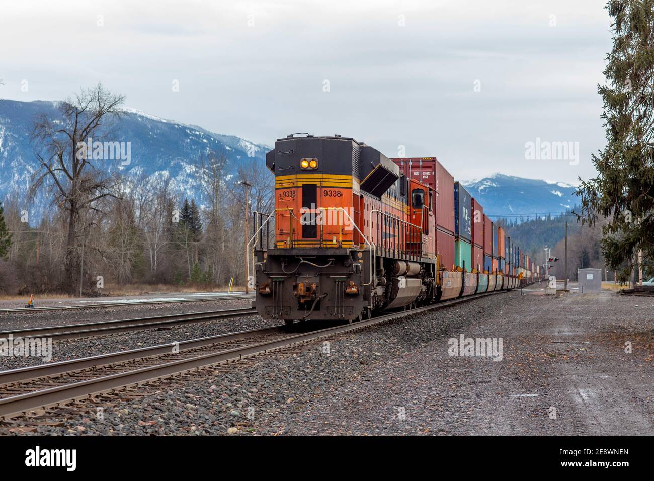 A BNSF train diesel electric push locomotive trailing a line of ...