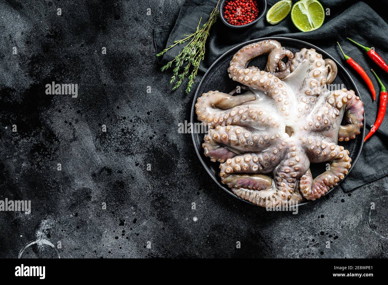 Fresh octopus with cooking ingredients, lime, thyme, chili pepper ...
