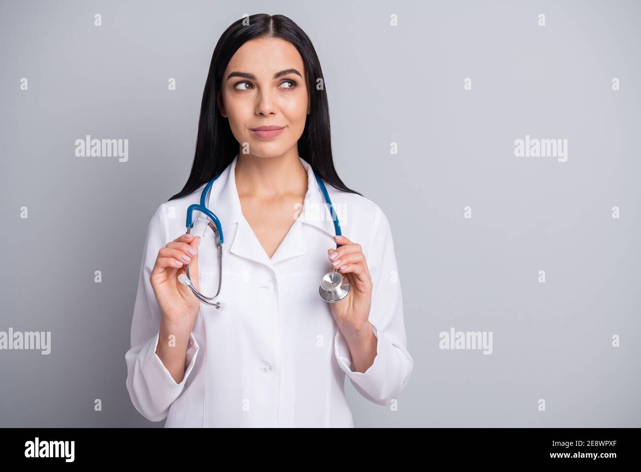 Photo of calm doctor lady hold equipment look side empty space wear ...