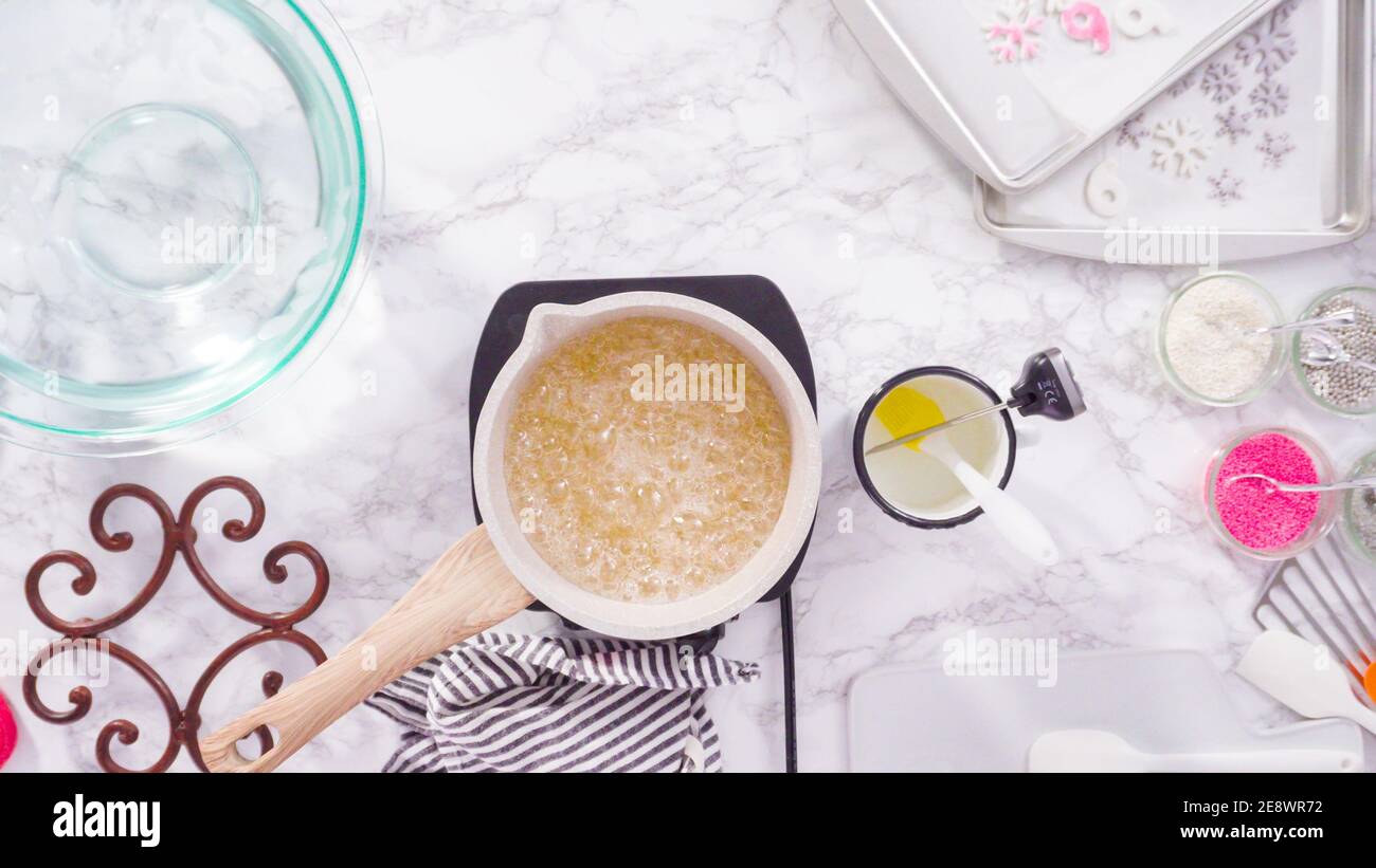 Flat lay. Step by step. Caramelizing sugar in a small cooking pot over ...