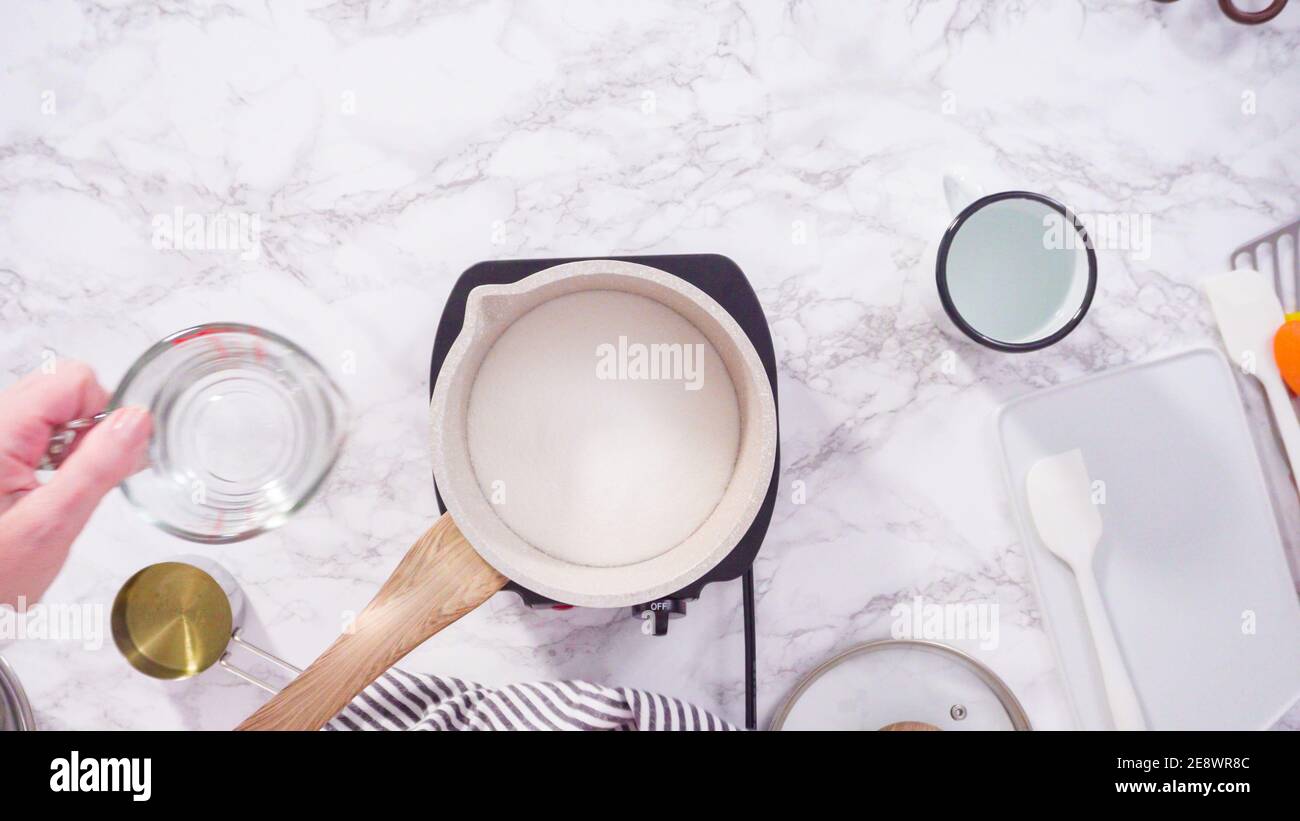 Flat lay. Step by step. Caramelizing sugar in a small cooking pot over ...