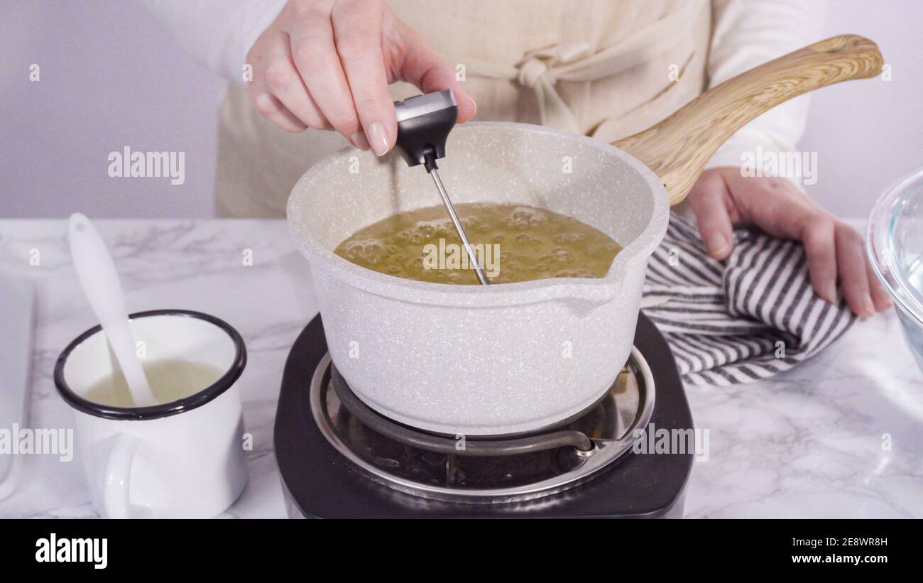 Step by step. Caramelizing sugar in a small cooking pot over the small ...