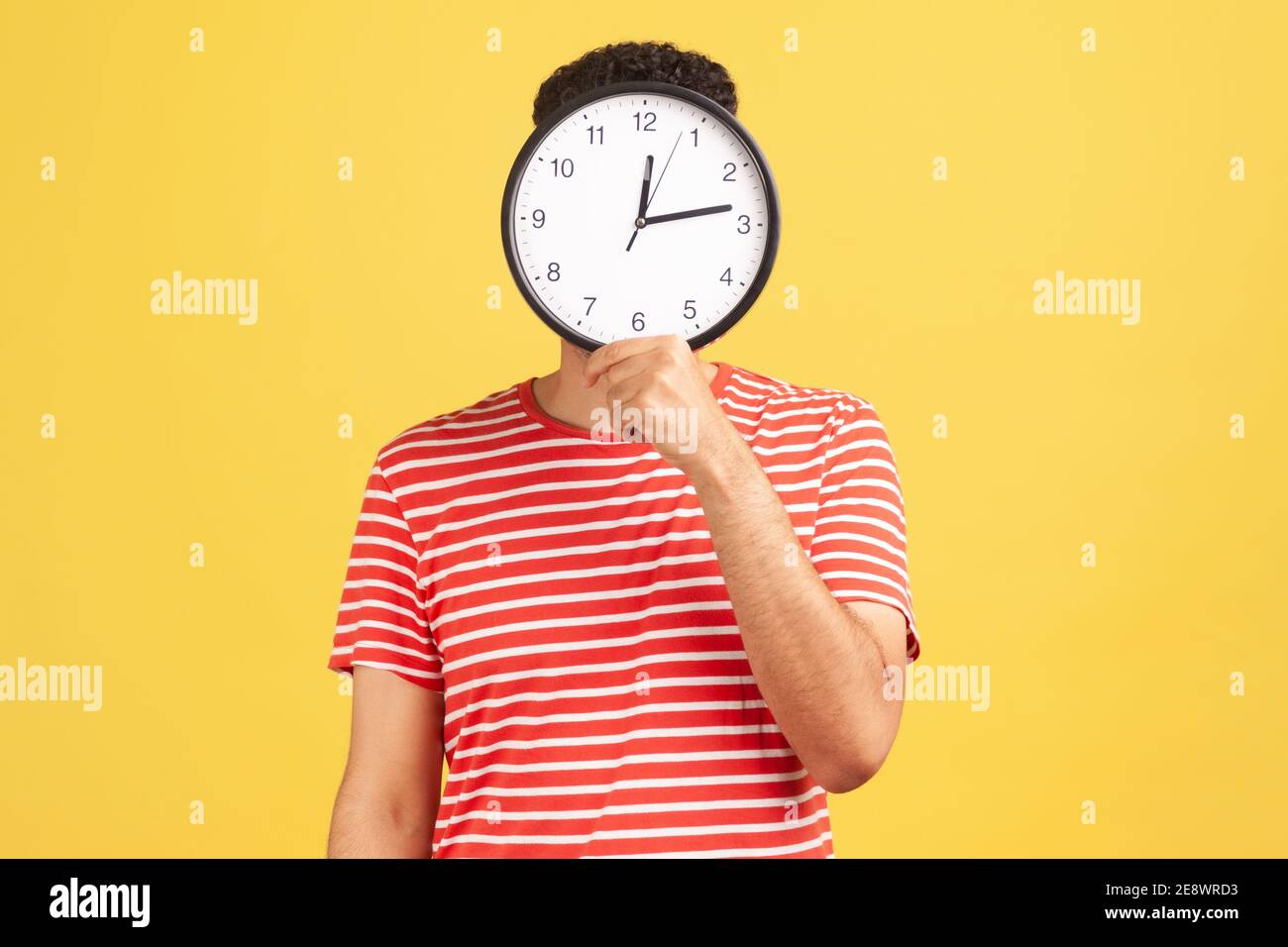 Isolated man hiding face with clock hi-res stock photography and images ...