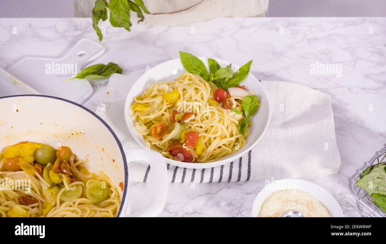 Step by step. Serving a one-pot pasta into a white pasta plate Stock ...
