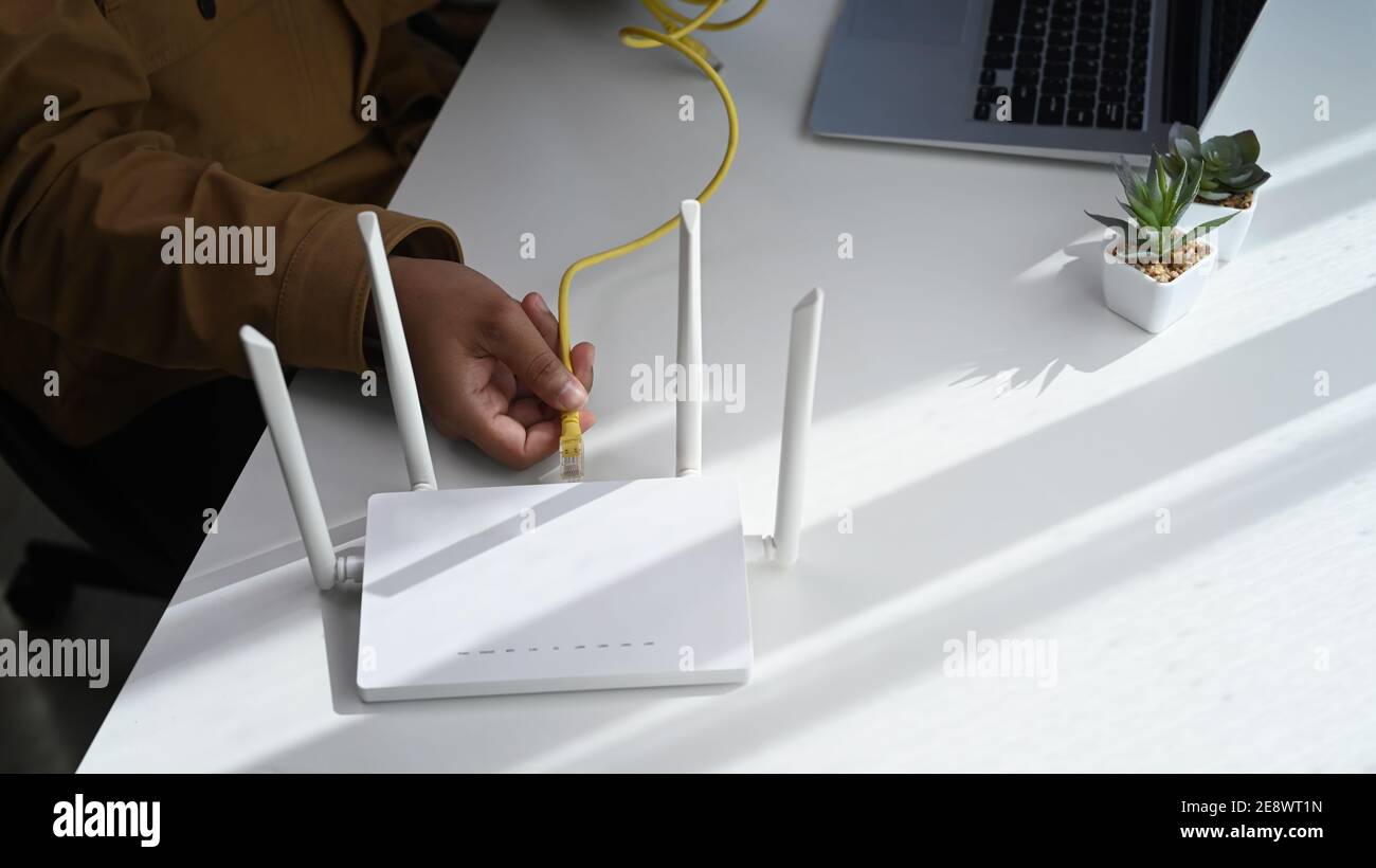 Plugging lan cable port hand hi-res stock photography and images - Alamy