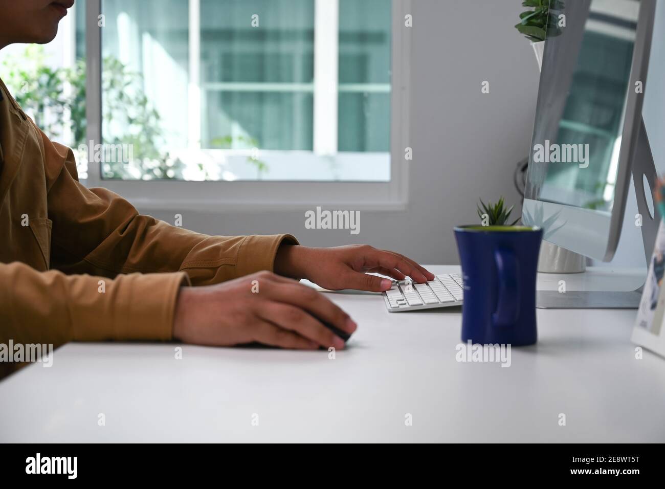 Cropped shot of man using computer working on new project idea at his ...