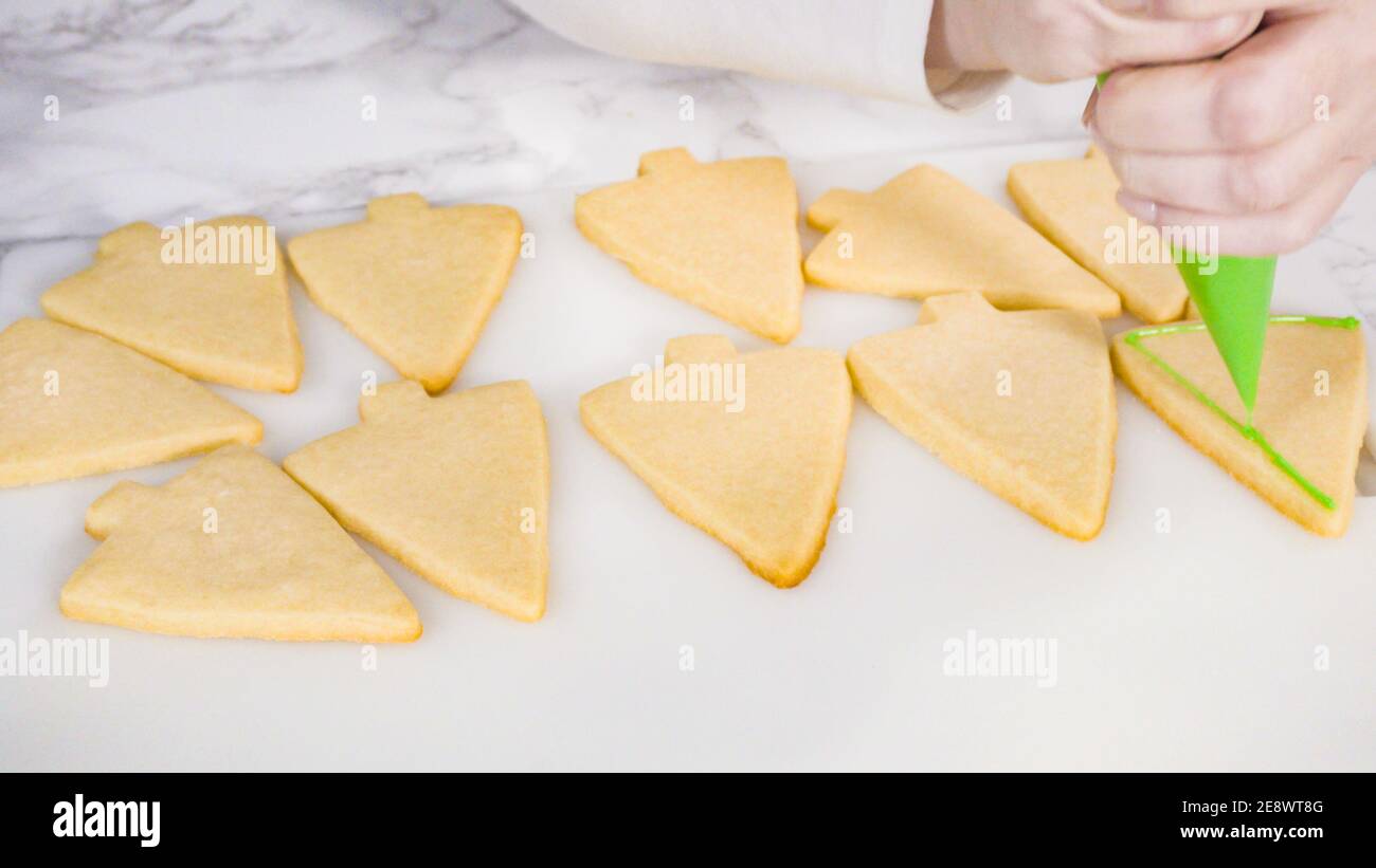 Stp by step. Icing Christmas tree-shaped sugar cookies with green royal ...