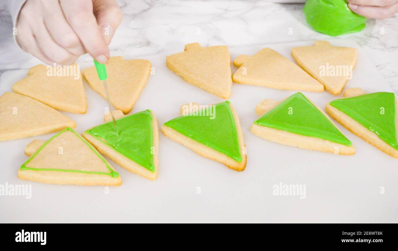 Stp by step. Icing Christmas tree-shaped sugar cookies with green royal ...