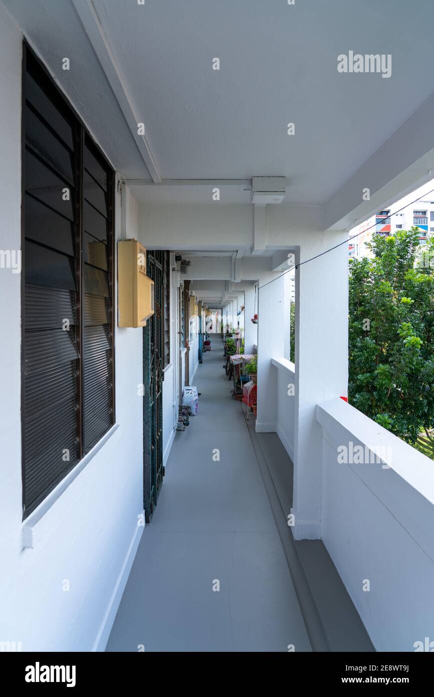 White long corridor from a public housing estate, HDB, Singapore Stock ...