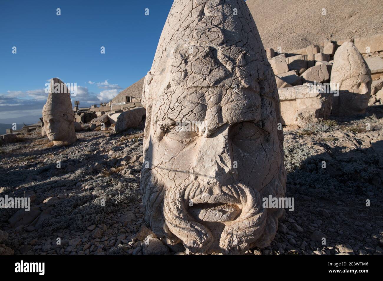 A close-up of an ancient stone head at Mount Nemrut, Turkey, revealing ...