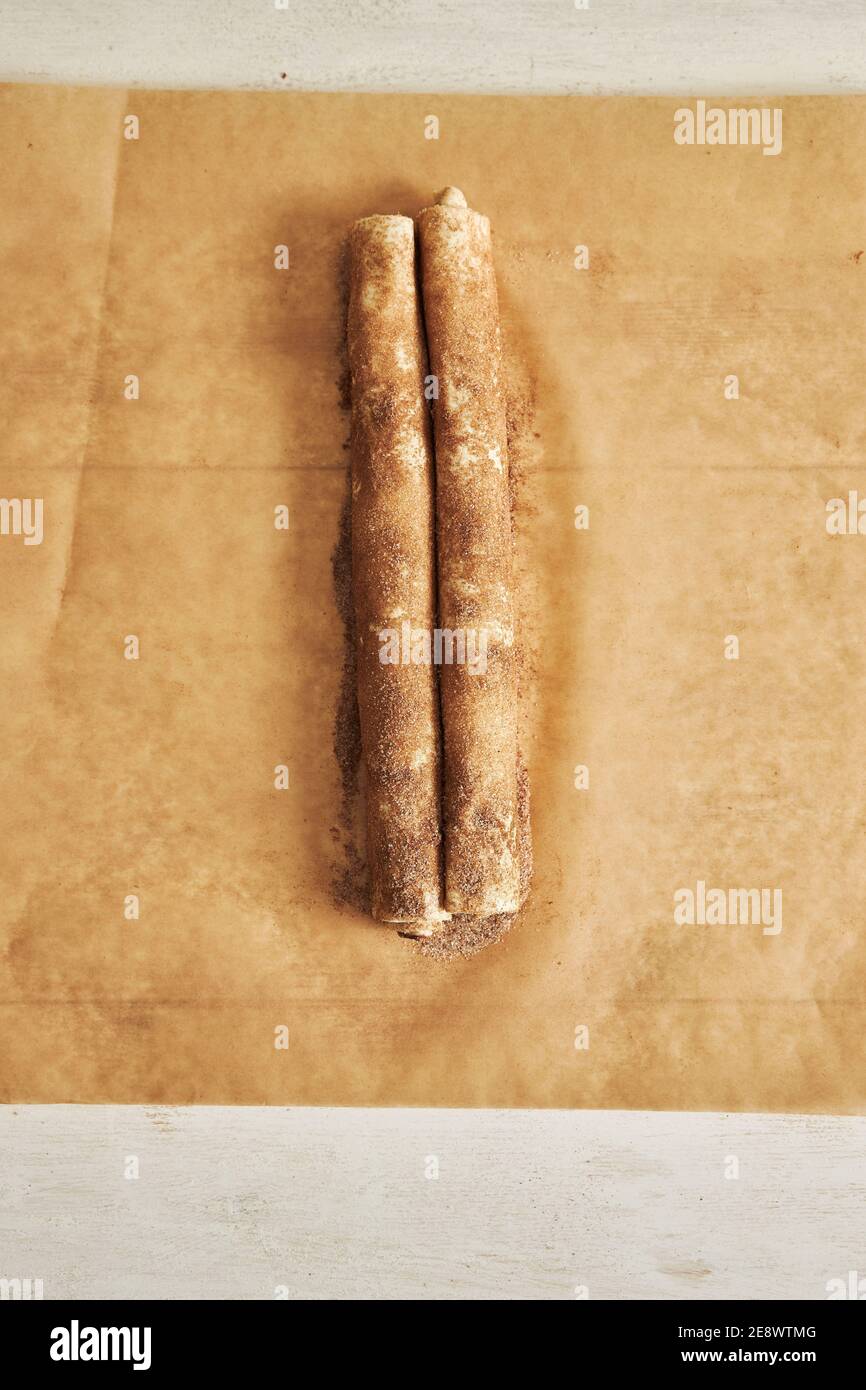 Top view of whole raw chocolate cinnamon rolls on a parchment paper ...