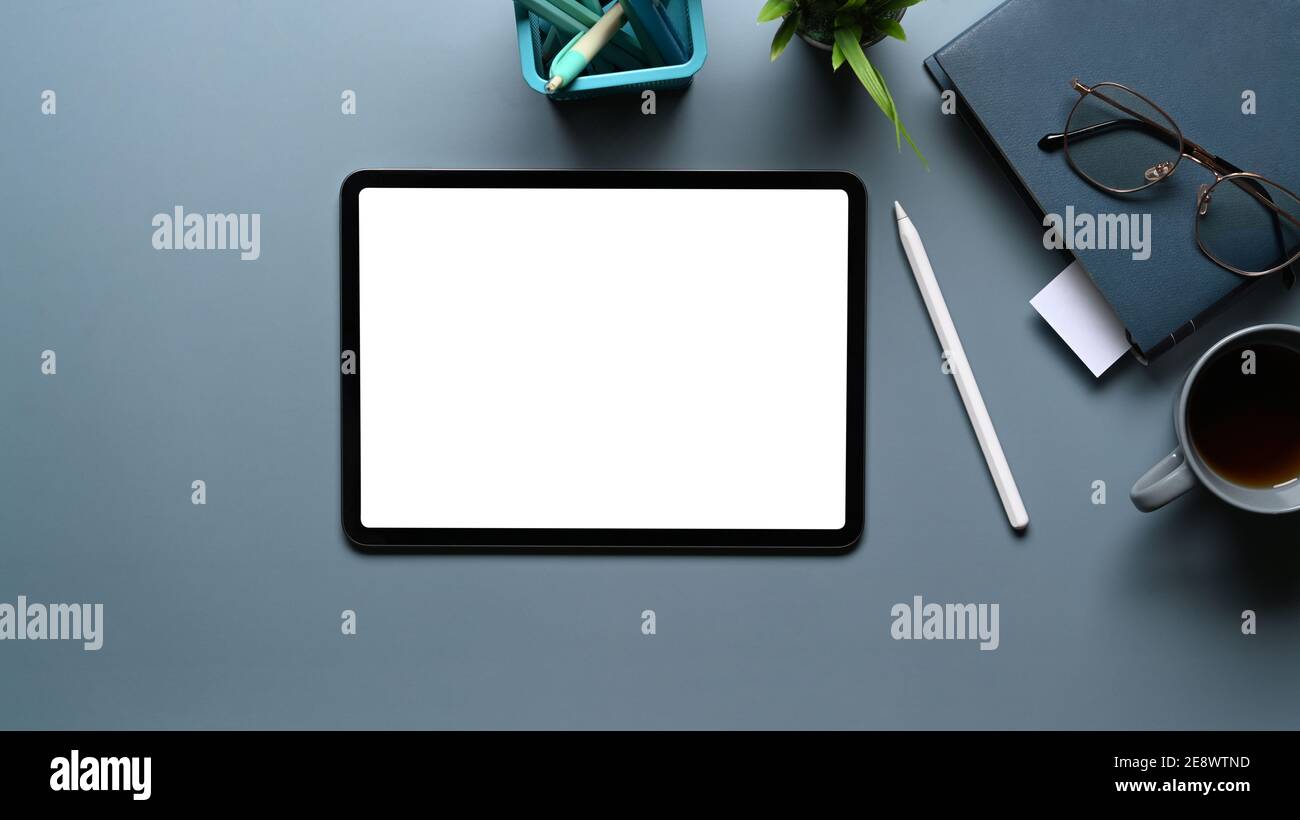 Flat lay photo of mock up digital tablet with empty screen on gray ...