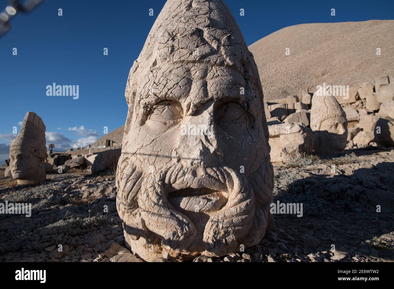 A close-up of an ancient stone head at Mount Nemrut, Turkey, revealing ...