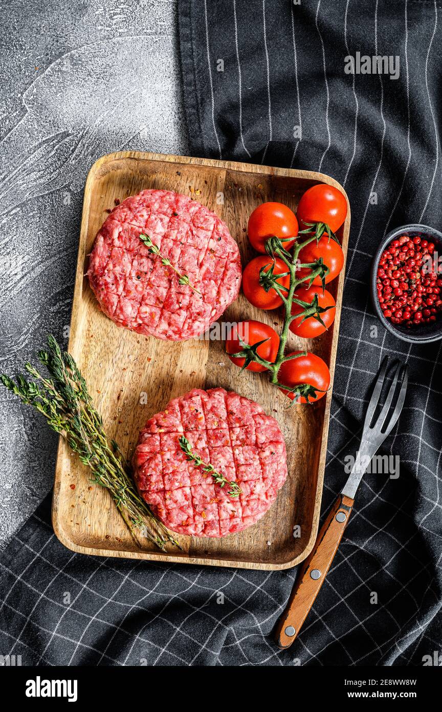 The ground beef patties, minced meat cutlets. Gray background. Top view ...