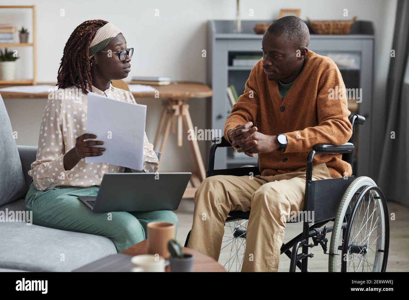 Portrait of African-American couple with handicapped man using ...