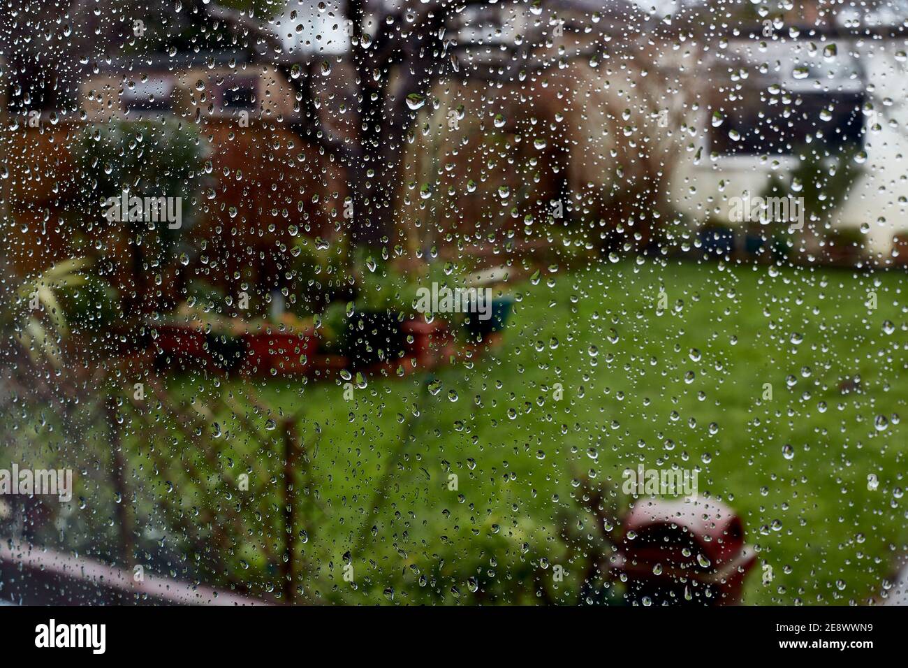 Abstract of raindrops on window with out of focus background in ...