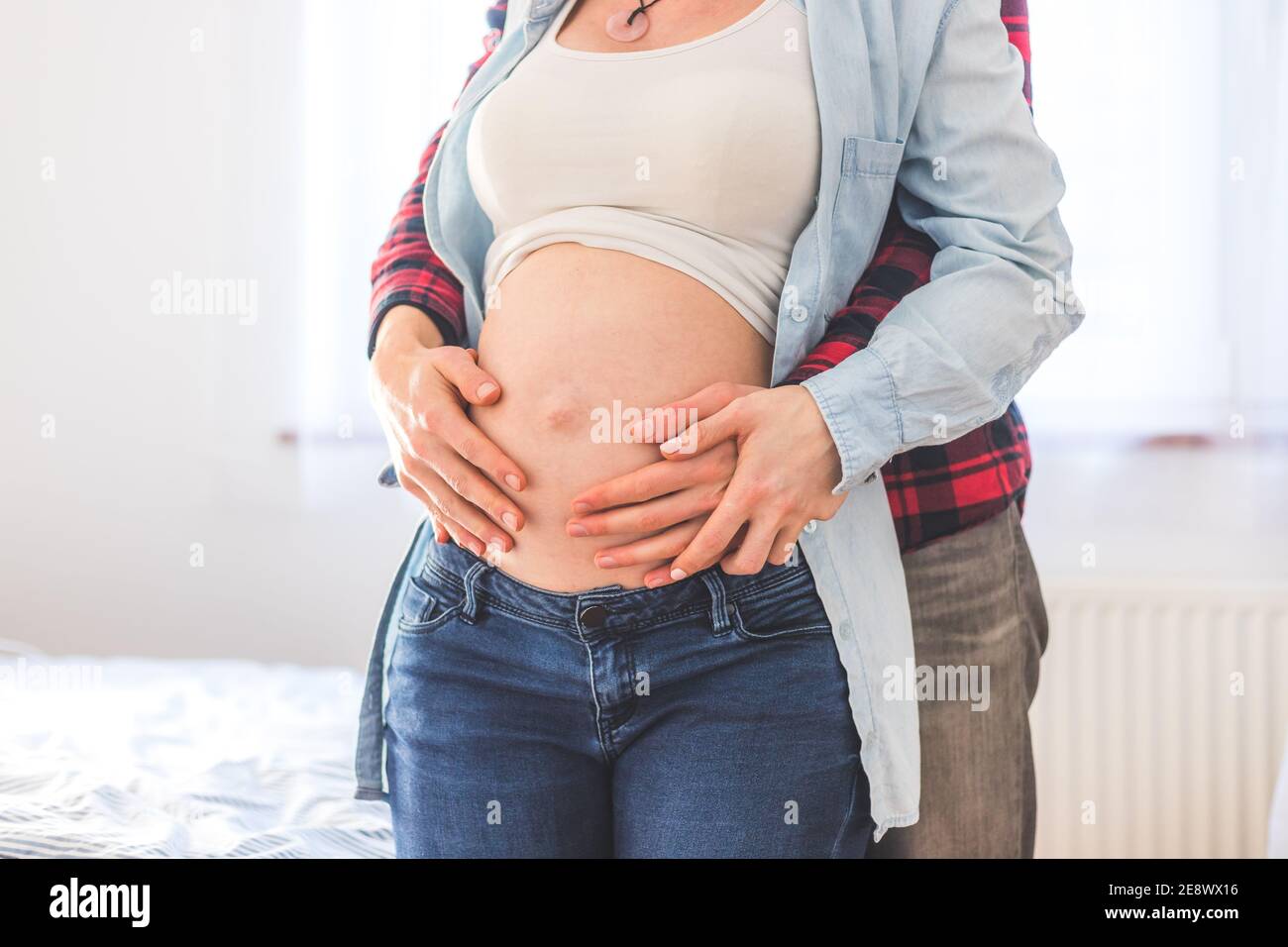 Close up of pregnant mother and father, hugging the tummy, Caucasian ...