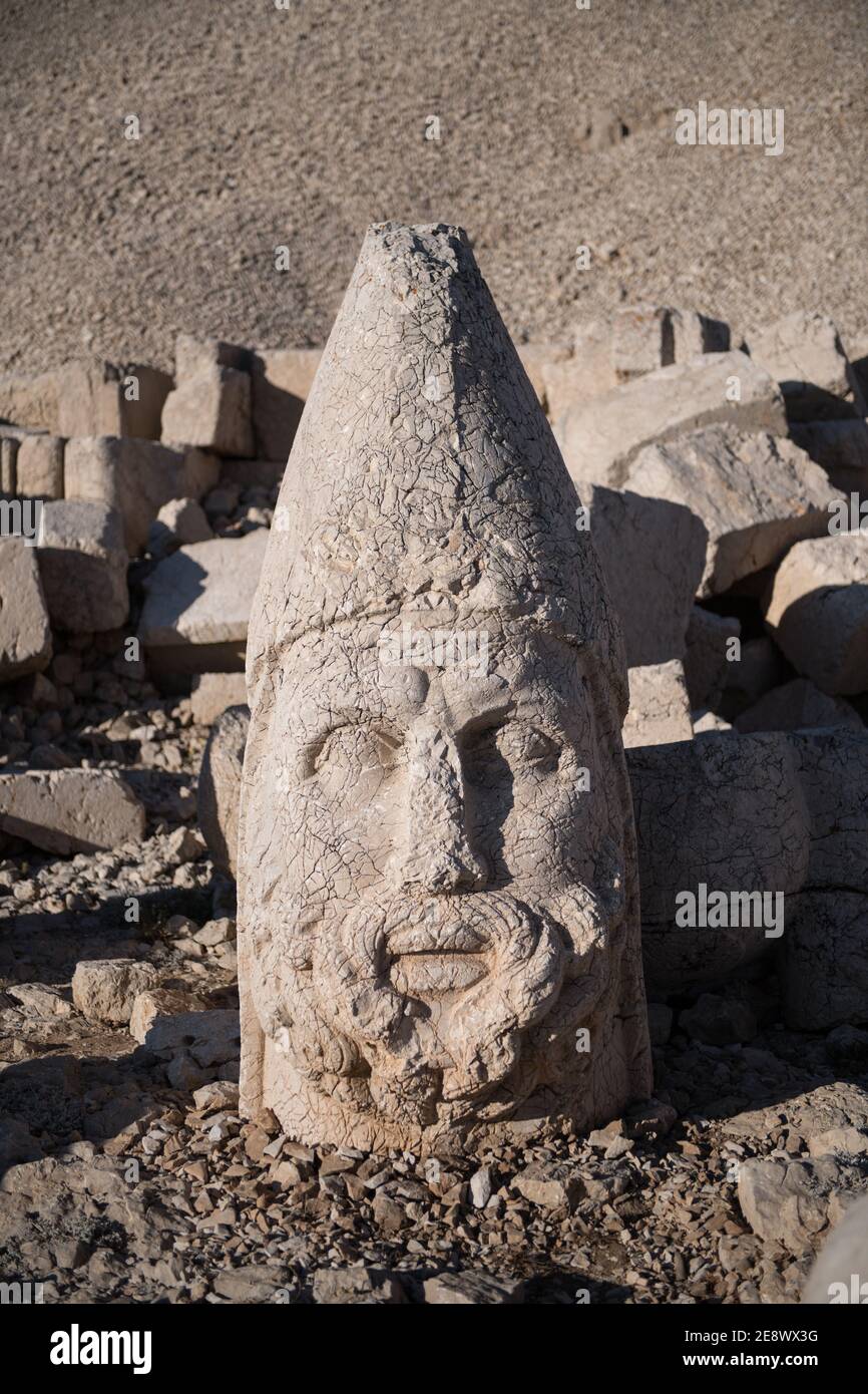 A close-up of an ancient stone head at Mount Nemrut, Turkey, revealing ...