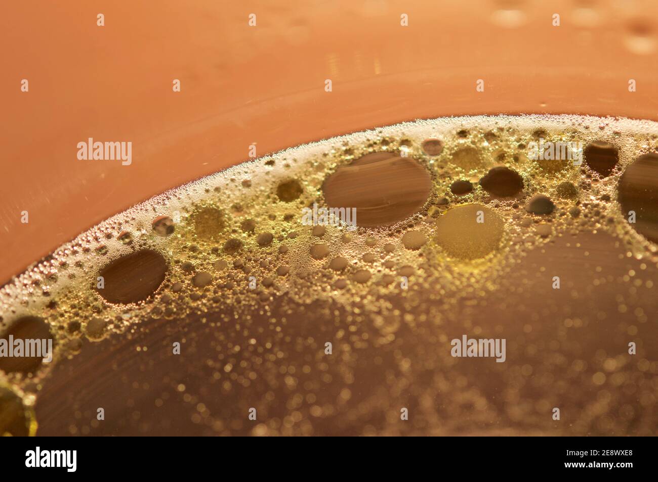 Macro shot of oil drops on soapy water Stock Photo - Alamy