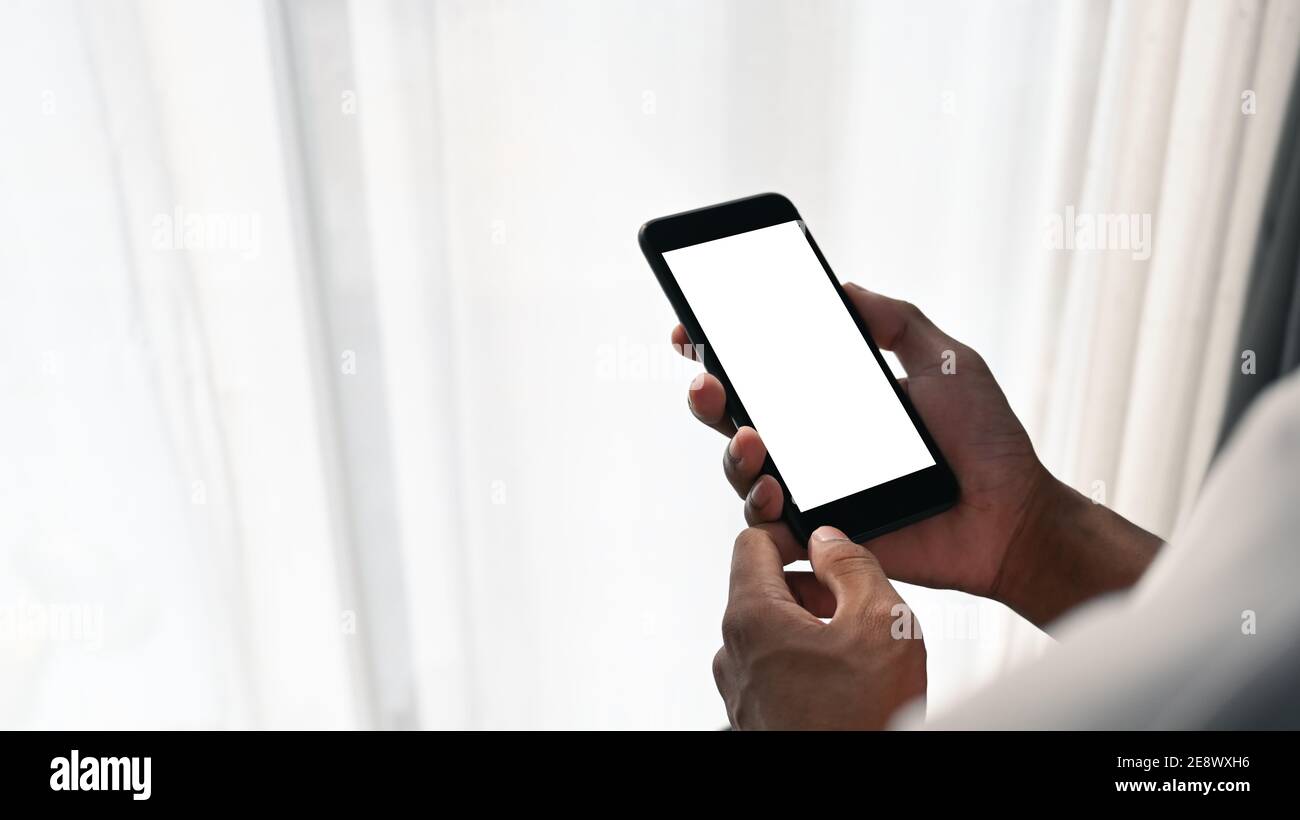 Mockup image of man hands holding mobile phone with blank white screen ...