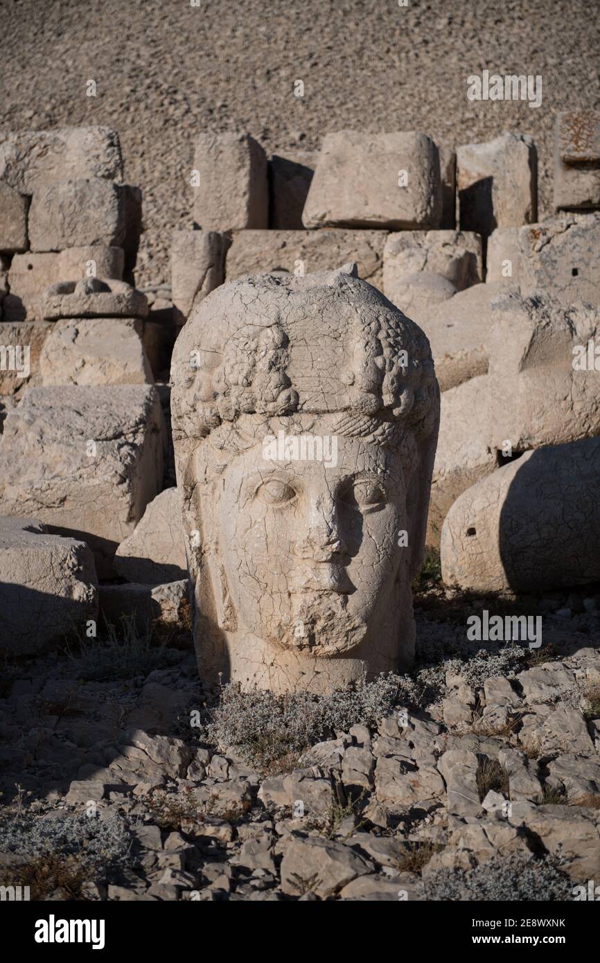 A close-up of an ancient stone head at Mount Nemrut, Turkey, revealing ...