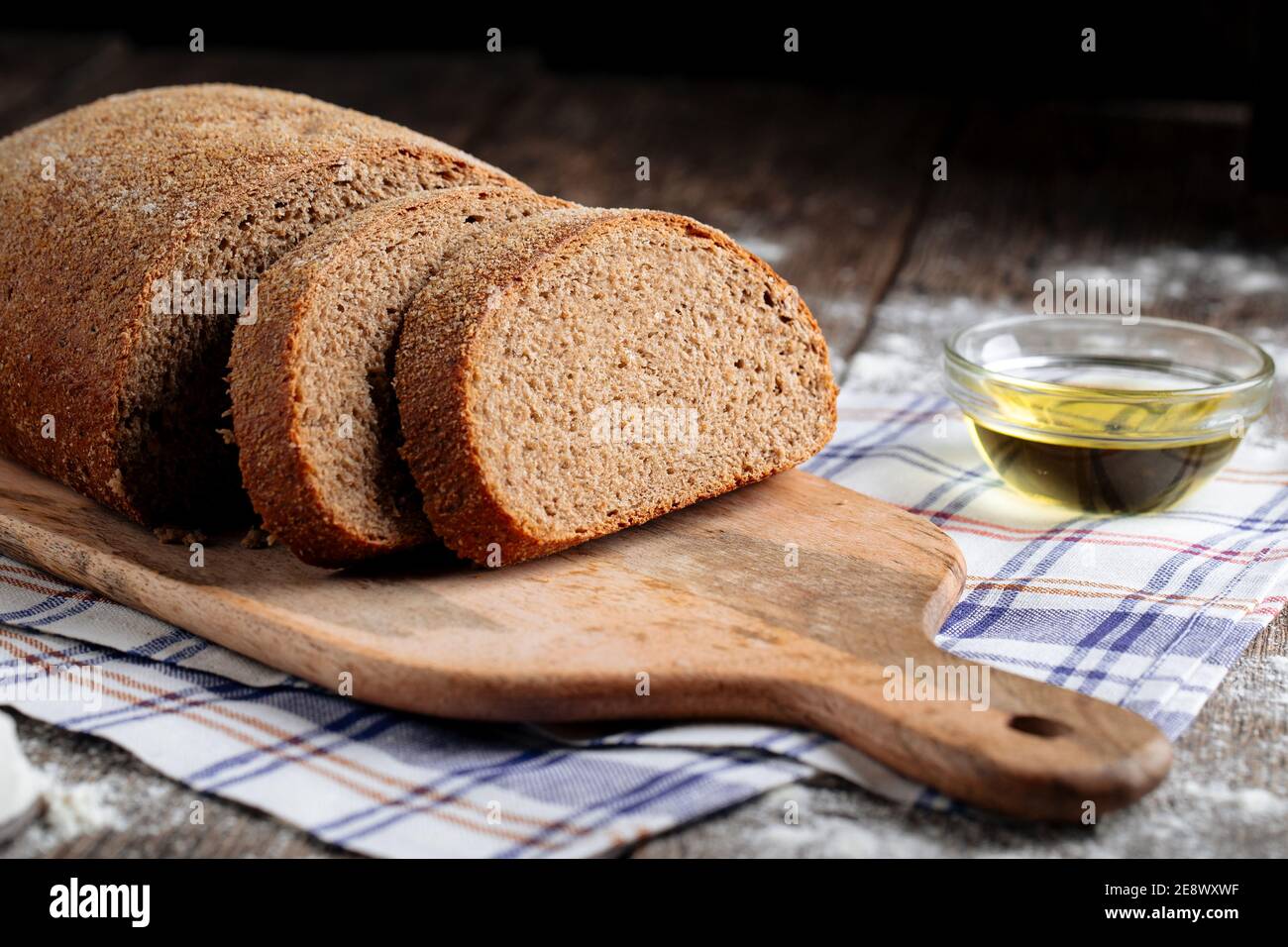 Closeup on sliced gray loaf of bread with oil Stock Photo - Alamy