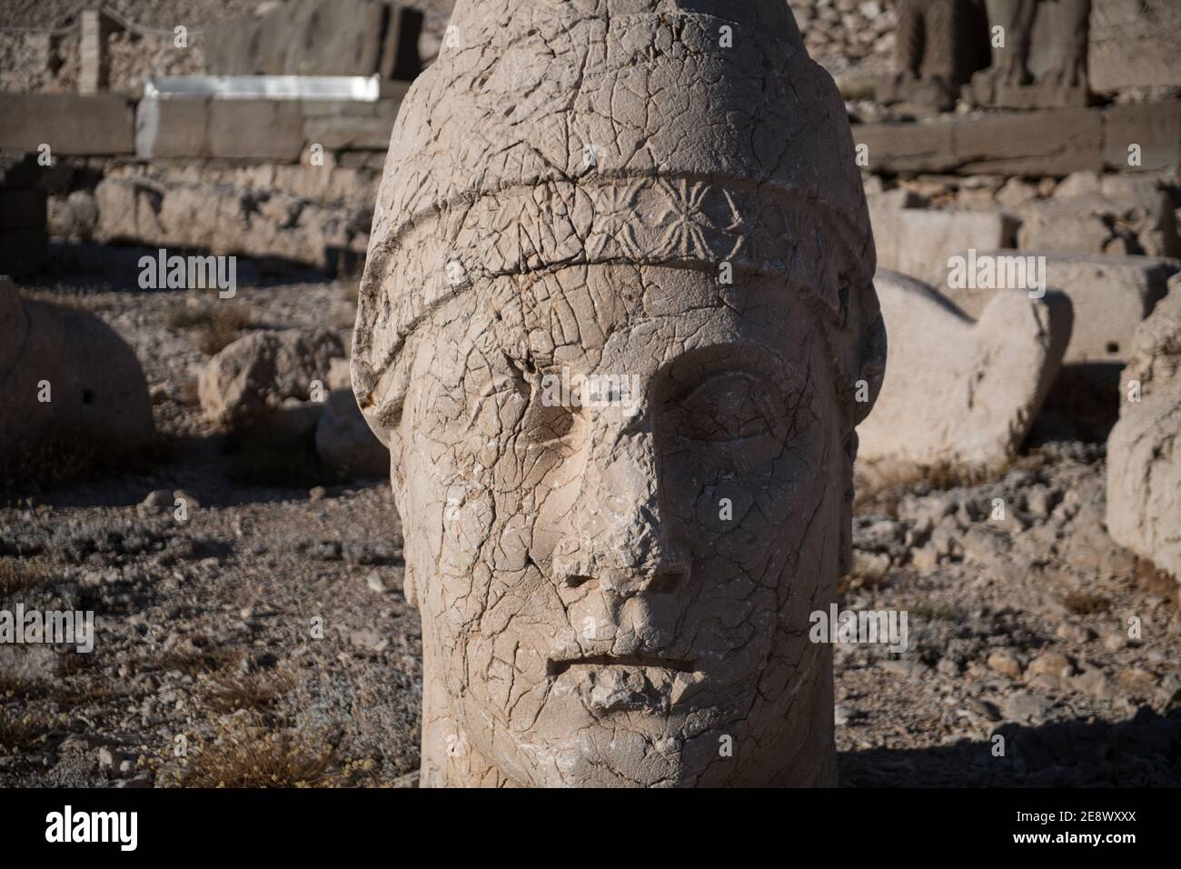 A close-up of an ancient stone head at Mount Nemrut, Turkey, revealing ...