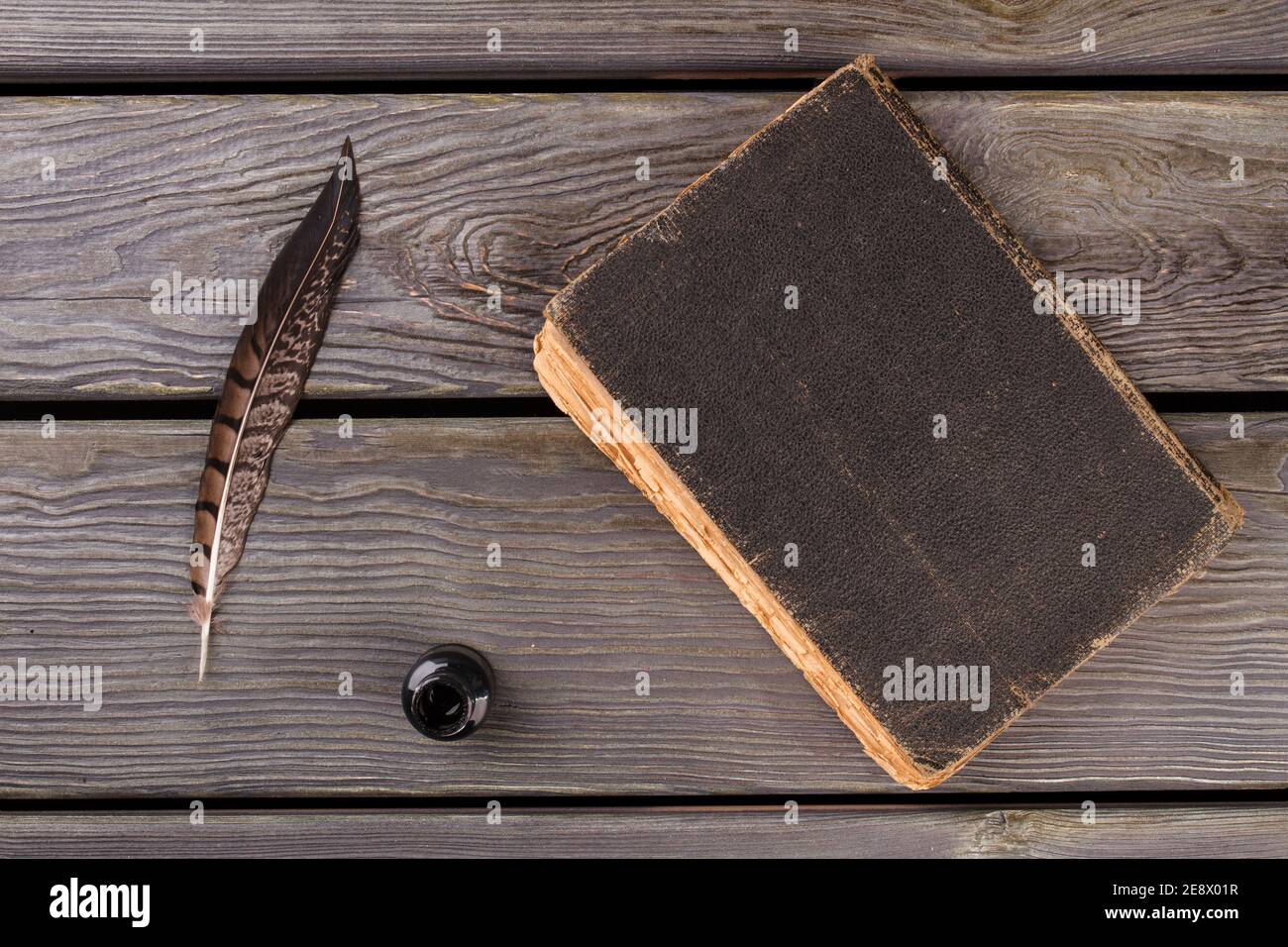 Top view old book with quill and inkpot Stock Photo - Alamy