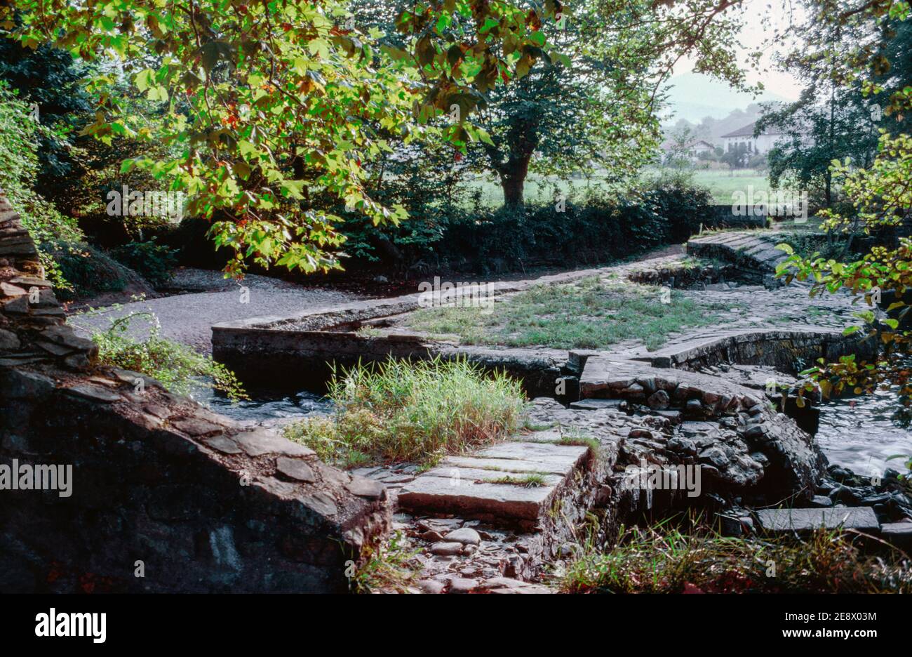 Roman mill dam below stone bridge on Nivelle river in Ascain, near ...