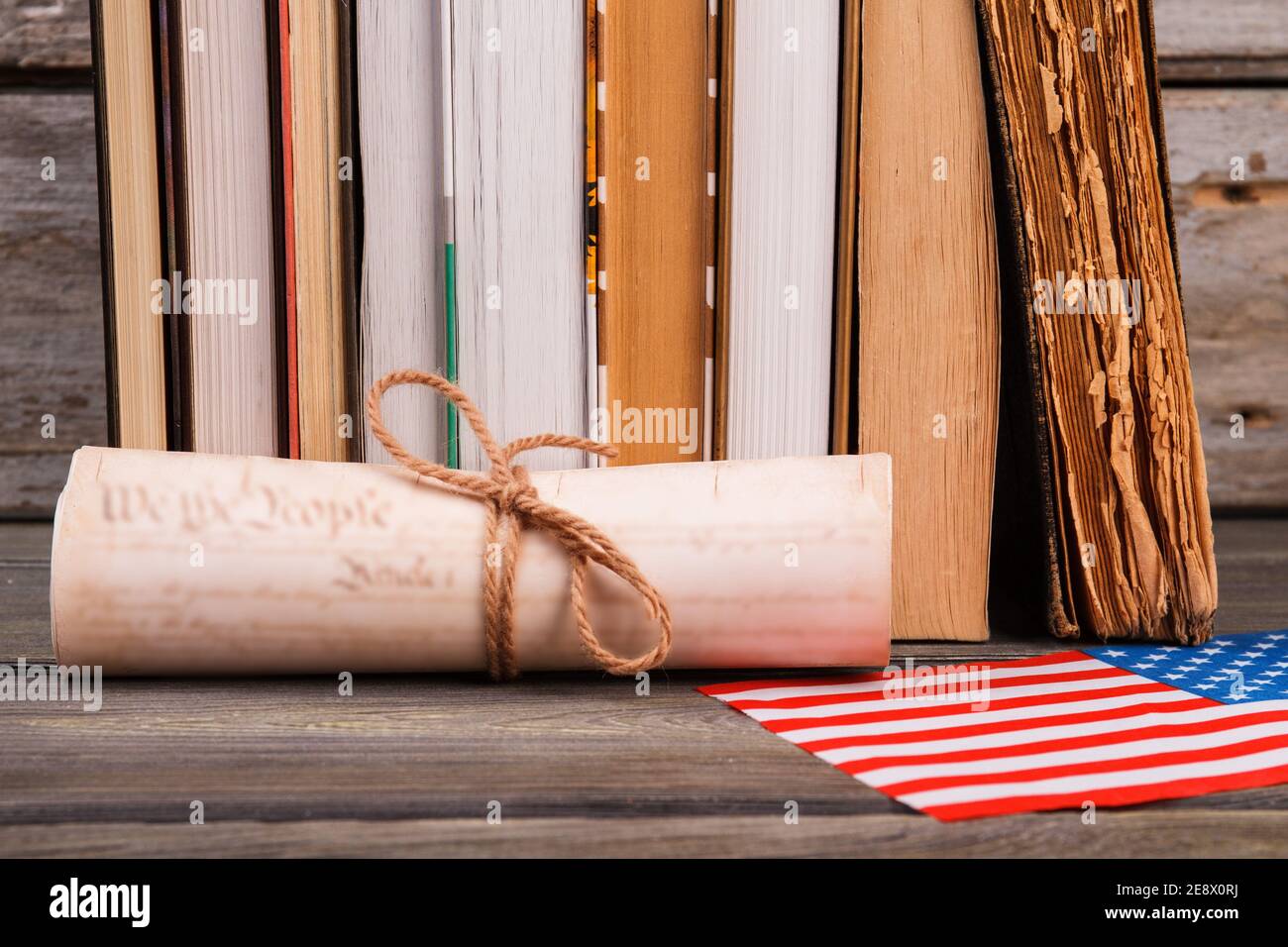 Scroll with books and usa flag Stock Photo - Alamy