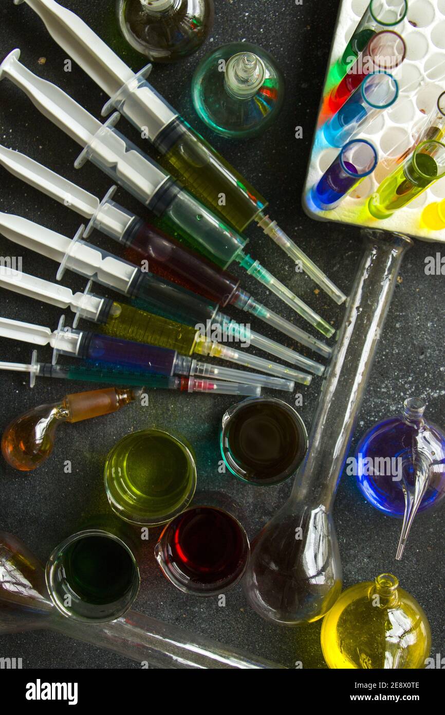 Top view of syringes filled with colorful chemicals in the laboratory ...